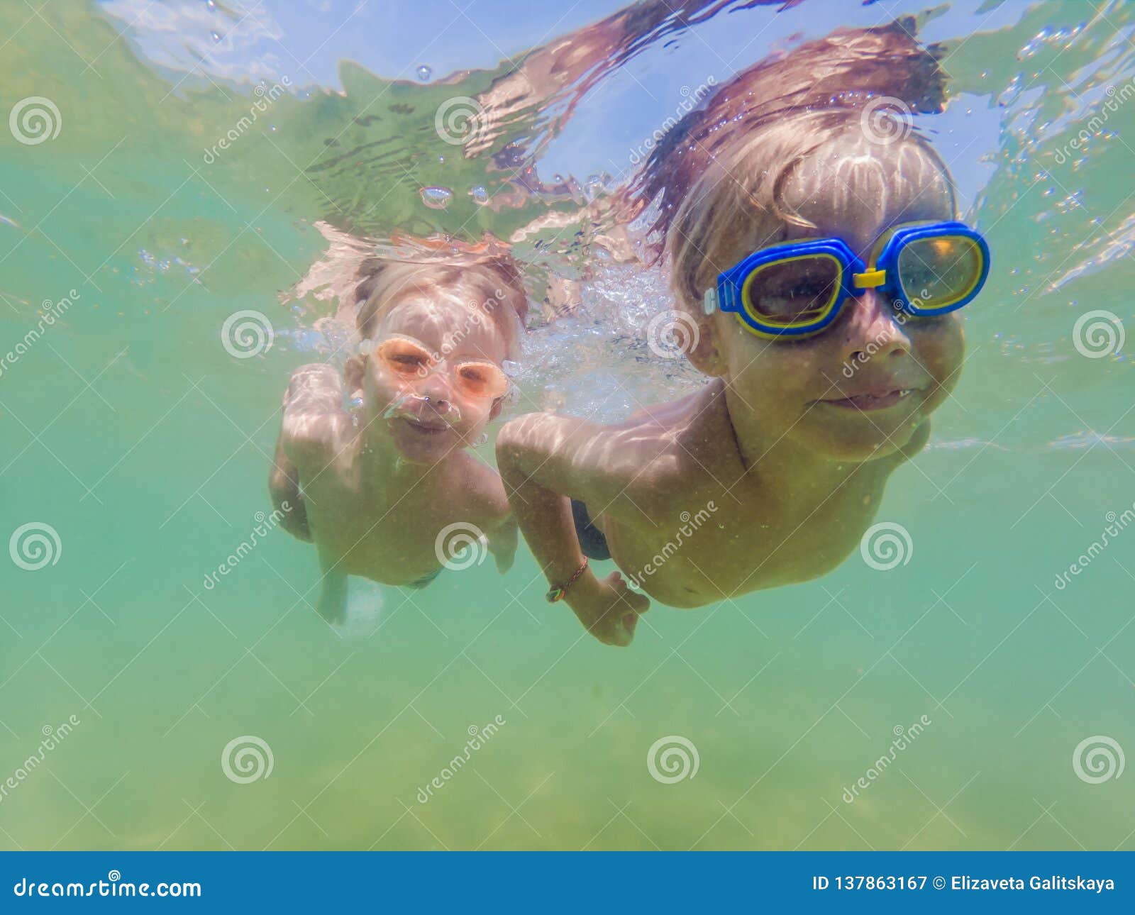 Two Boys Dive in Swimming Goggles in the Sea Stock Image - Image of ...
