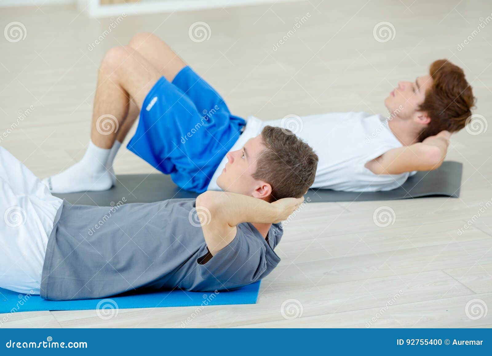 Two Boys Doing Situp Workout Training in Gym Stock Photo - Image of ...