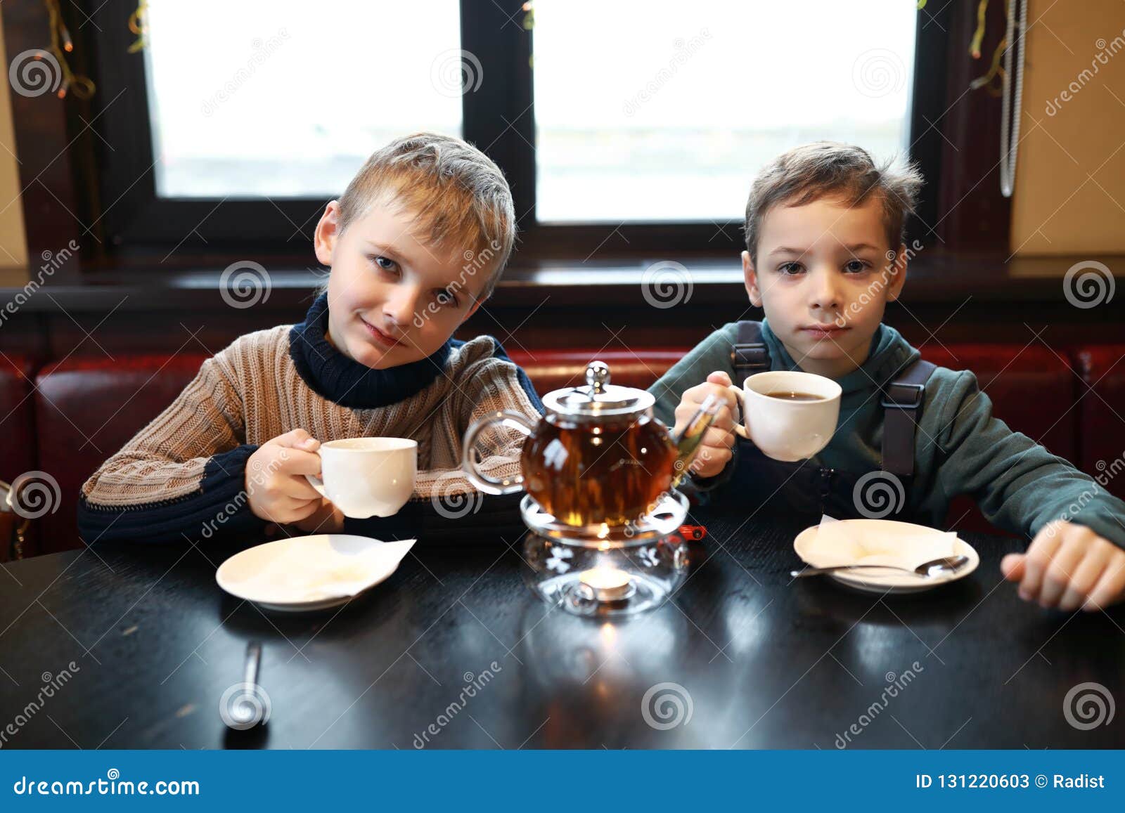Two boys drink tea stock image. Image of cafeteria, face - 131220603