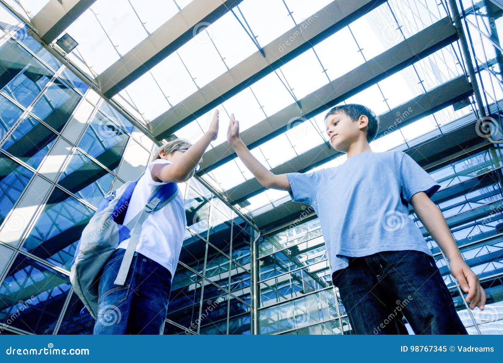 Two Boys Giving Each Other a High Five Outdoors Stock Image - Image of ...