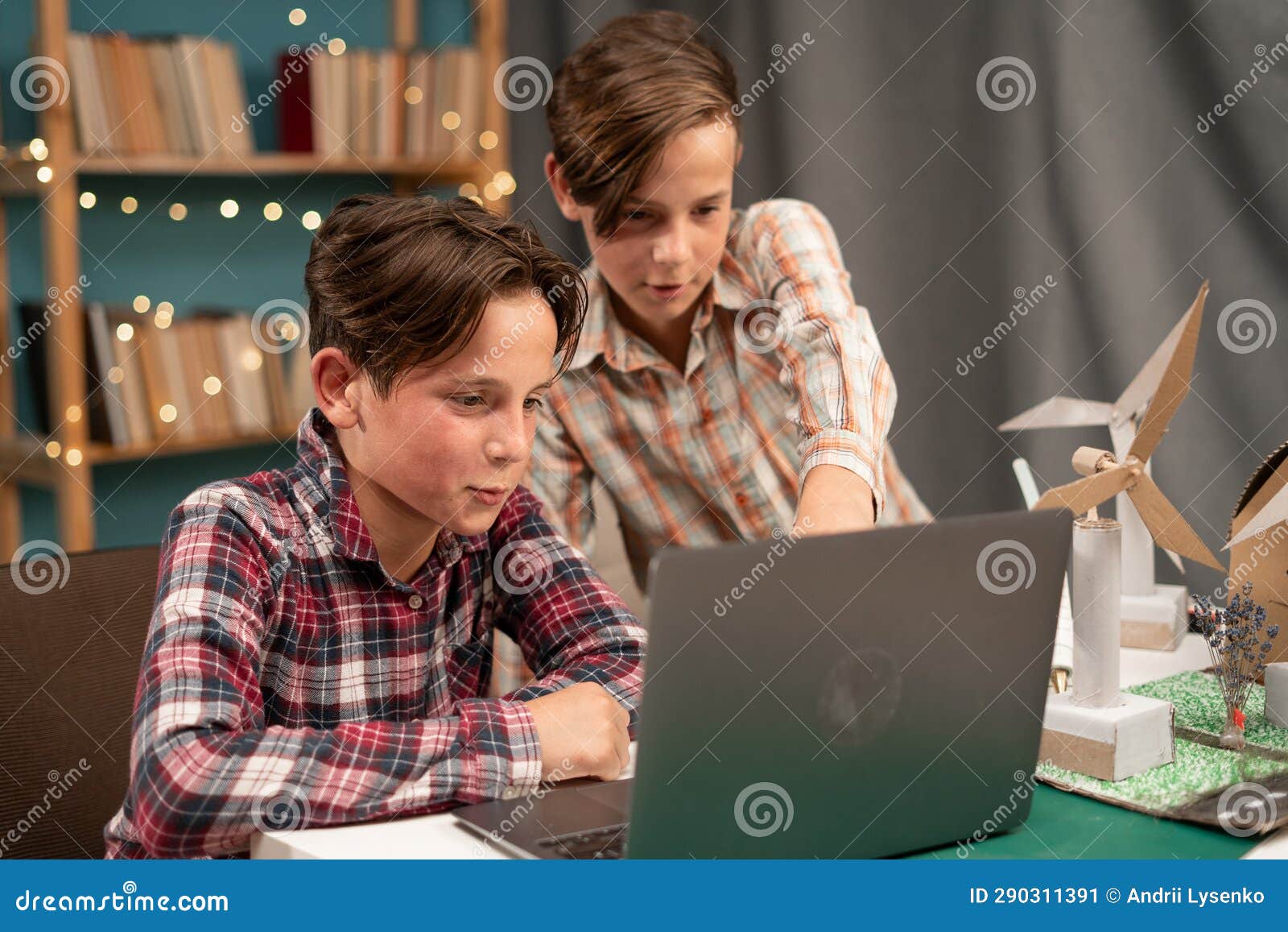 Two Boys Learning about Eco-friendly Renewable Sources of Energy Using ...