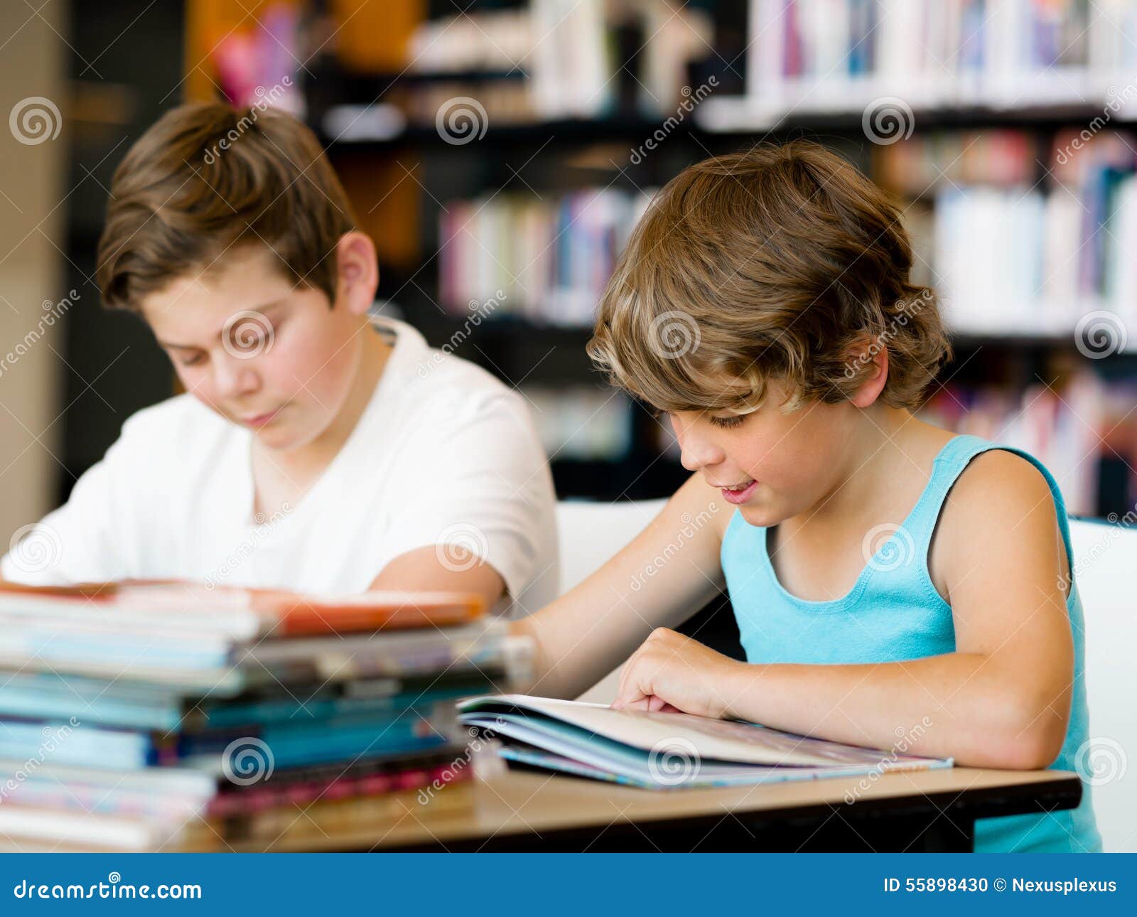 Two boys in library stock photo. Image of school, pupil - 55898430
