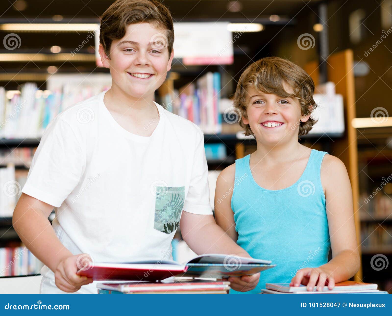 Two boys in library stock image. Image of knowledge - 101528047