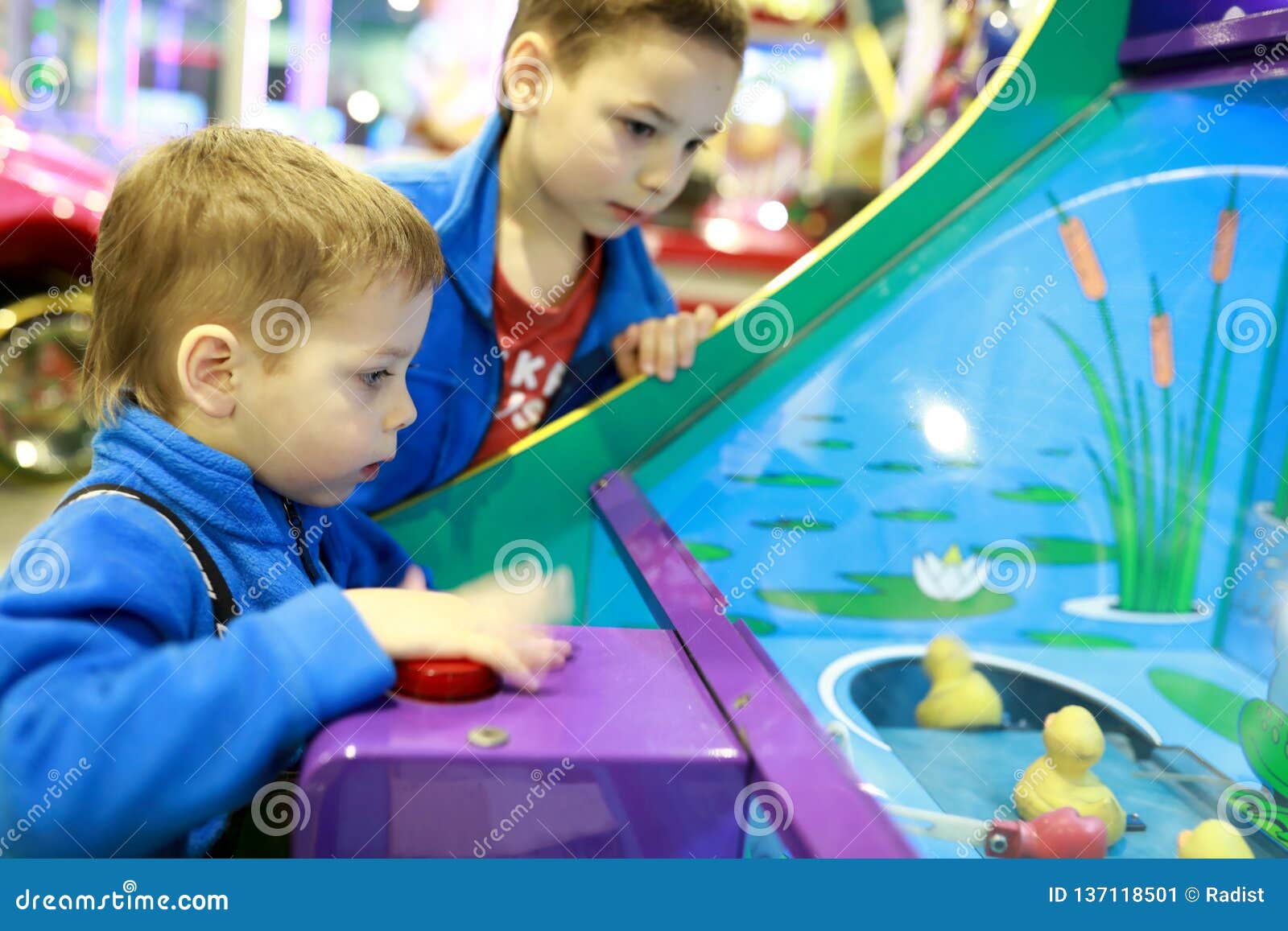 Two Boys Playing Arcade Game Stock Image - Image of action, arcade ...