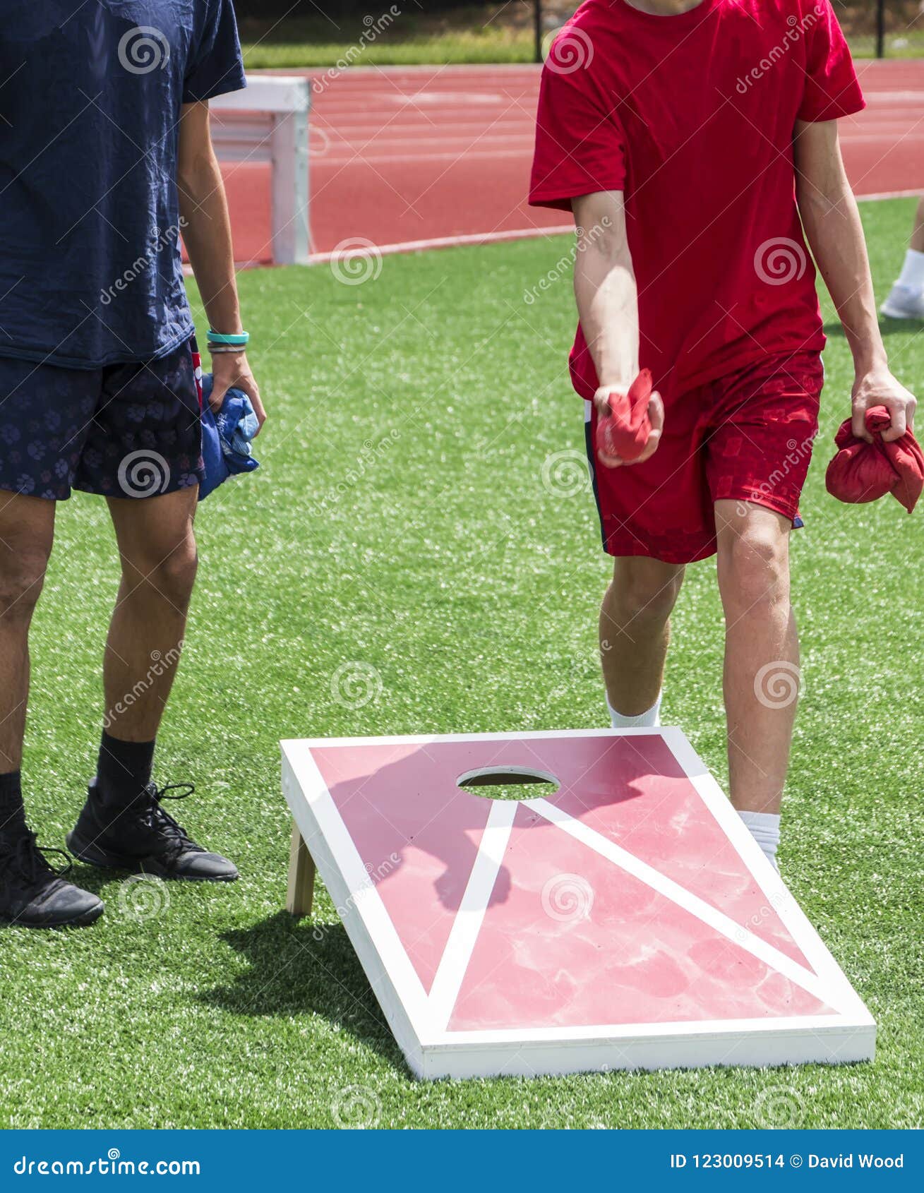 Two boys playing corn hole stock photo. Image of white - 123009514