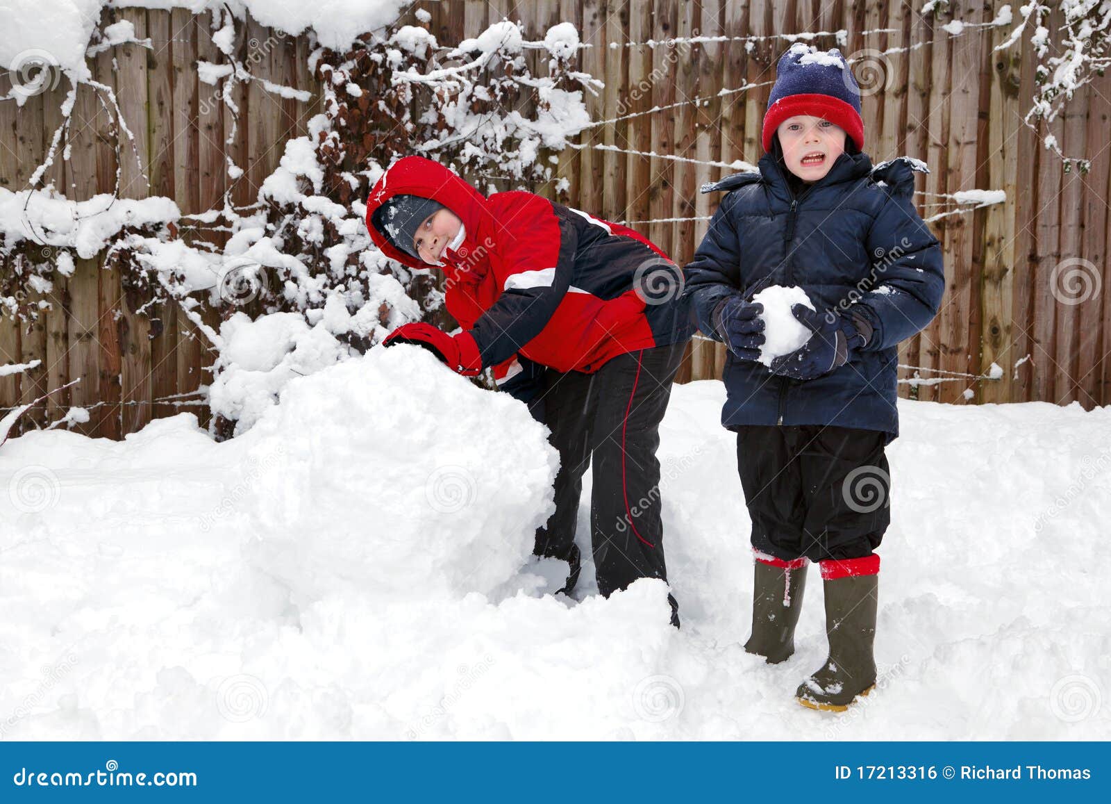 Two Boys Playing in the Snow Stock Photo - Image of snowday, playing ...