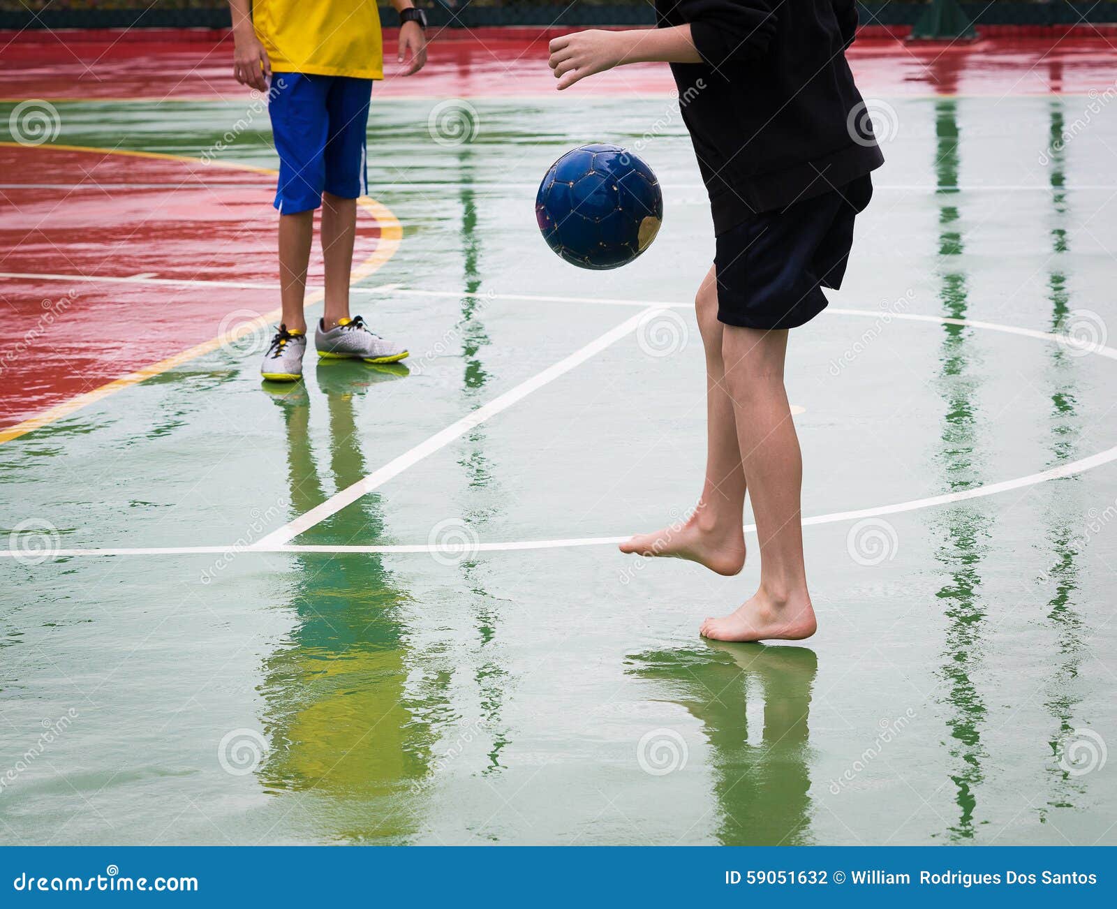 Kids Playing Soccer In The Rain