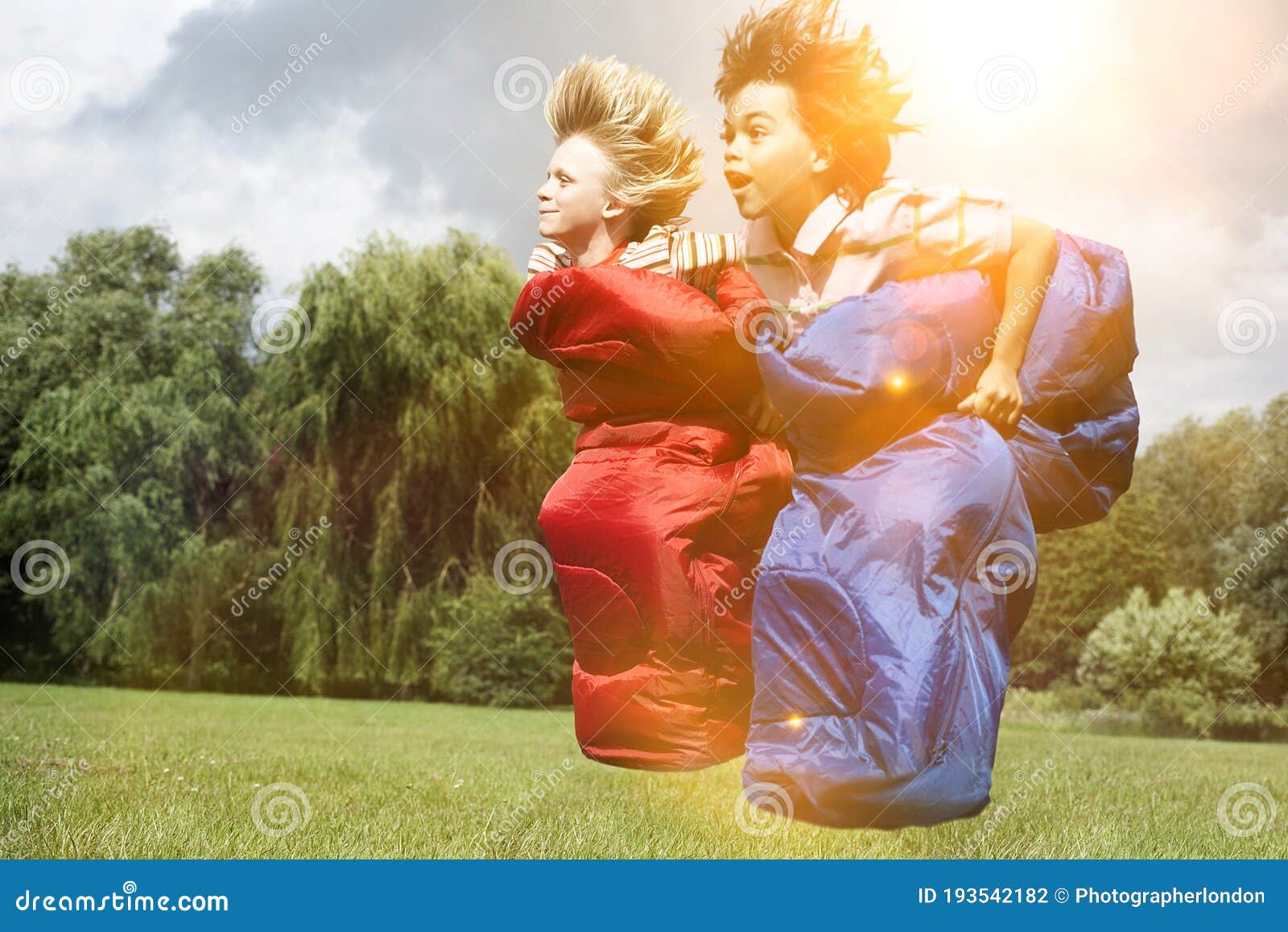 Two Boys Racing in Sleeping Bags Stock Photo - Image of green ...