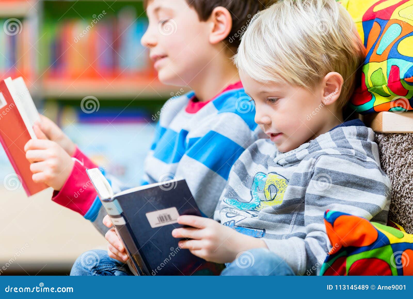 Two Boys Reading Books in the Library Stock Image - Image of people ...