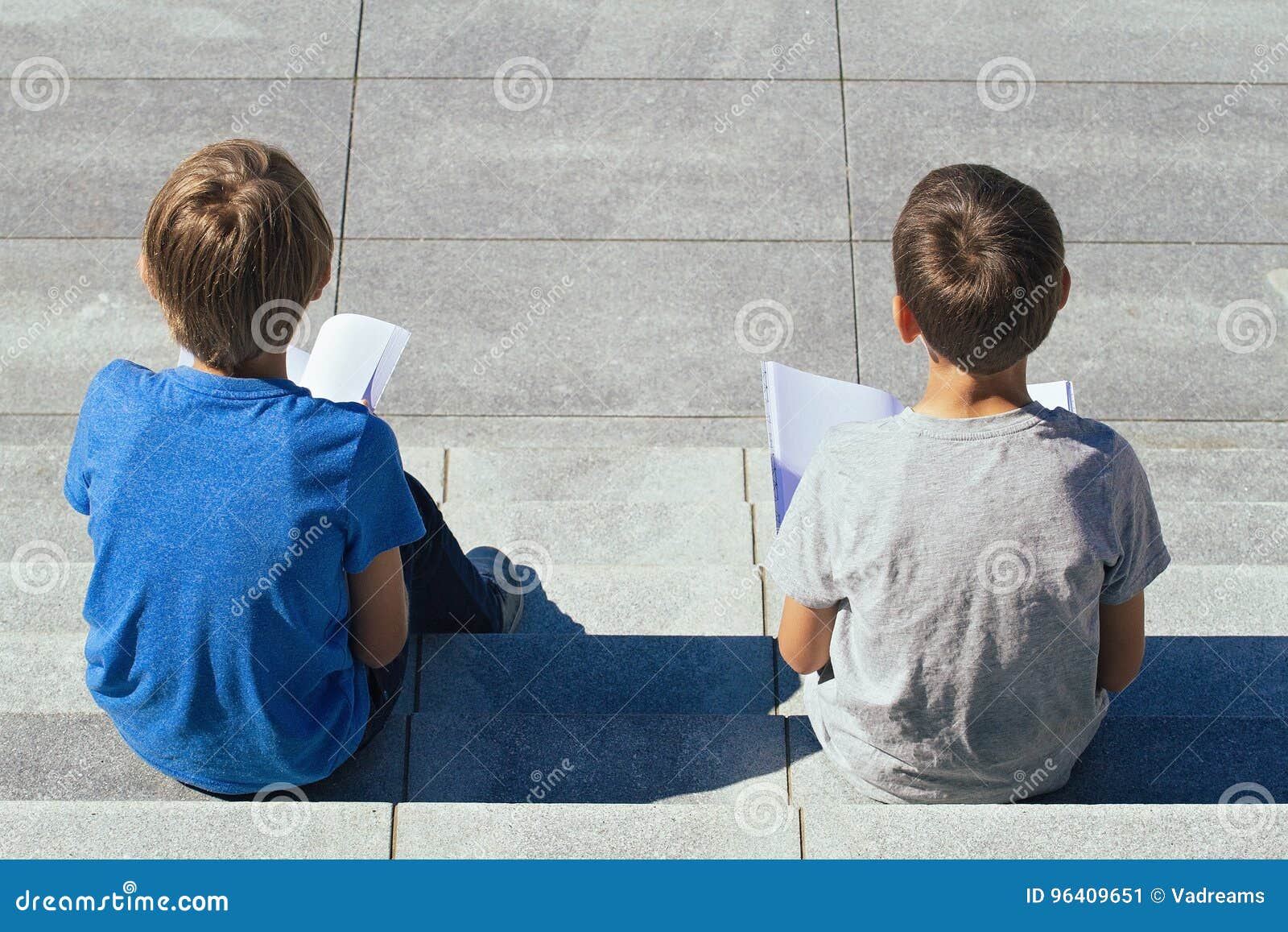 Two Boys Reading Books Sitting on the Stairs Outdoors Stock Image ...