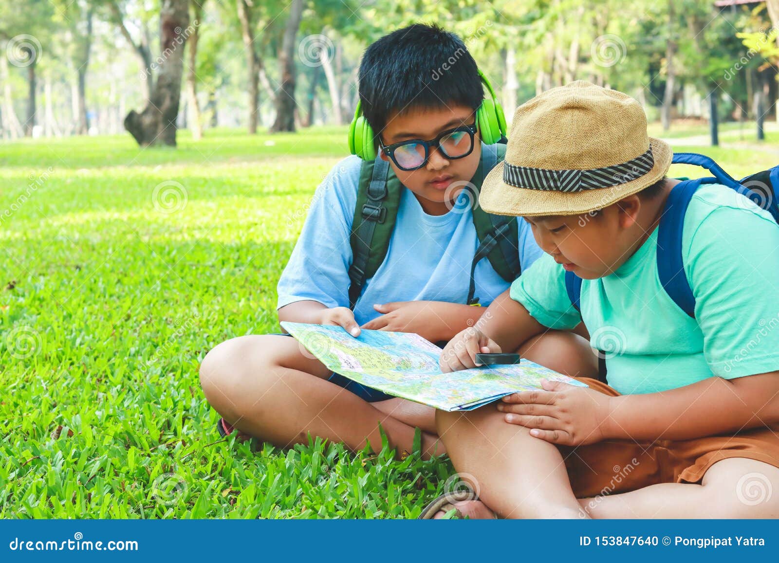 Two boys watch the map stock photo. Image of children - 153847640