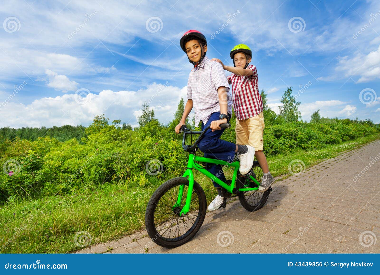 Two Boys Riding Same Bike and Both Stand Stock Photo - Image of ...