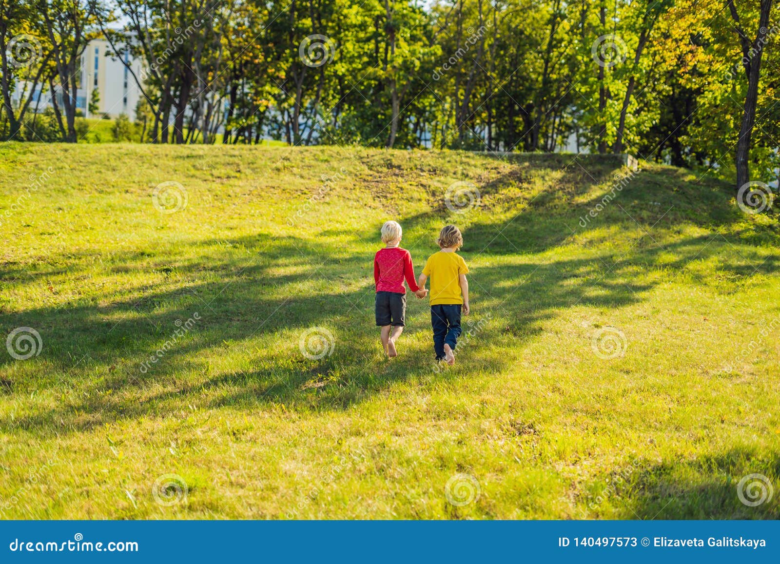 Two Boys Running in the Park through the Grass Stock Image - Image of ...