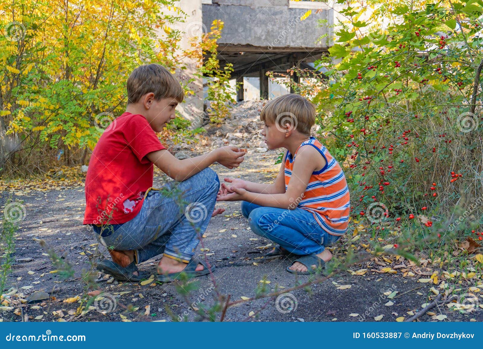Two Boys Sit Opposite Each Other in the Park and Communicate with Each ...