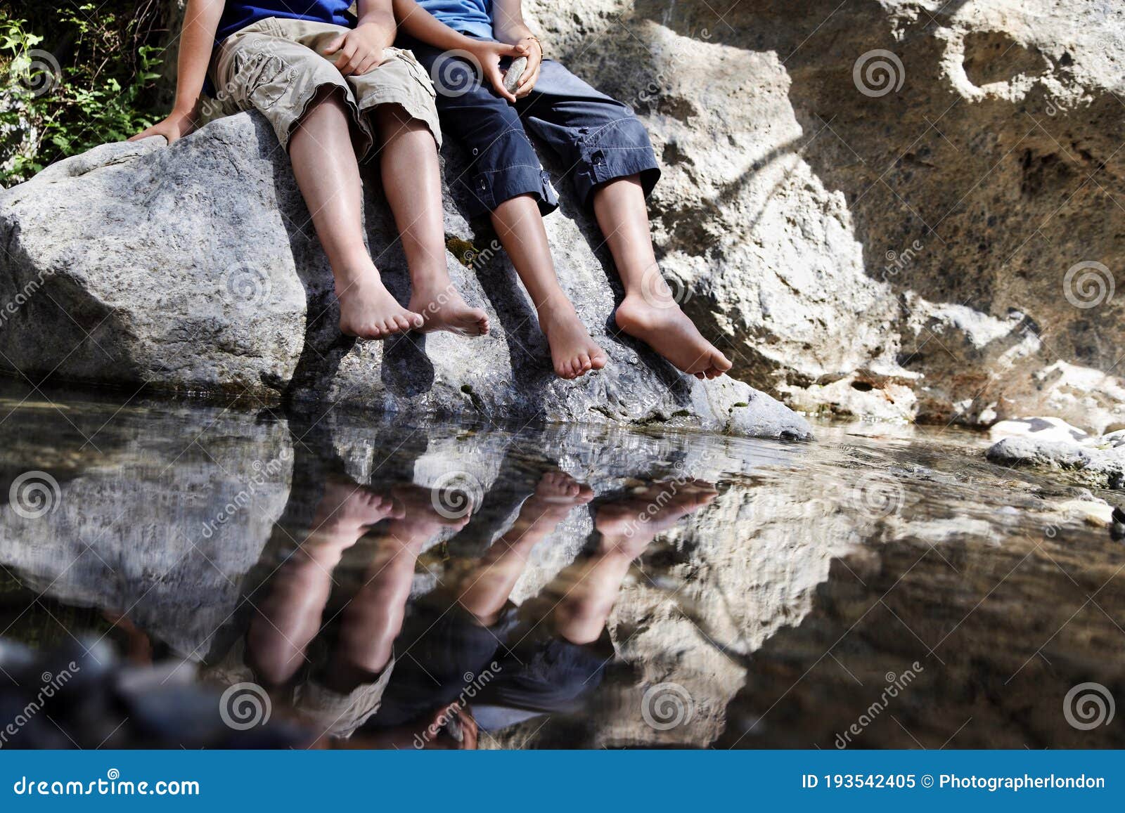 Two Boys Sitting on Rock by River Stock Image - Image of water, family ...