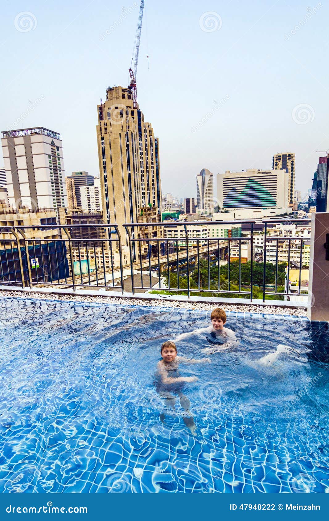 Two Boys Swim in a Rooftop Pool Stock Photo - Image of skyscraper, pool ...