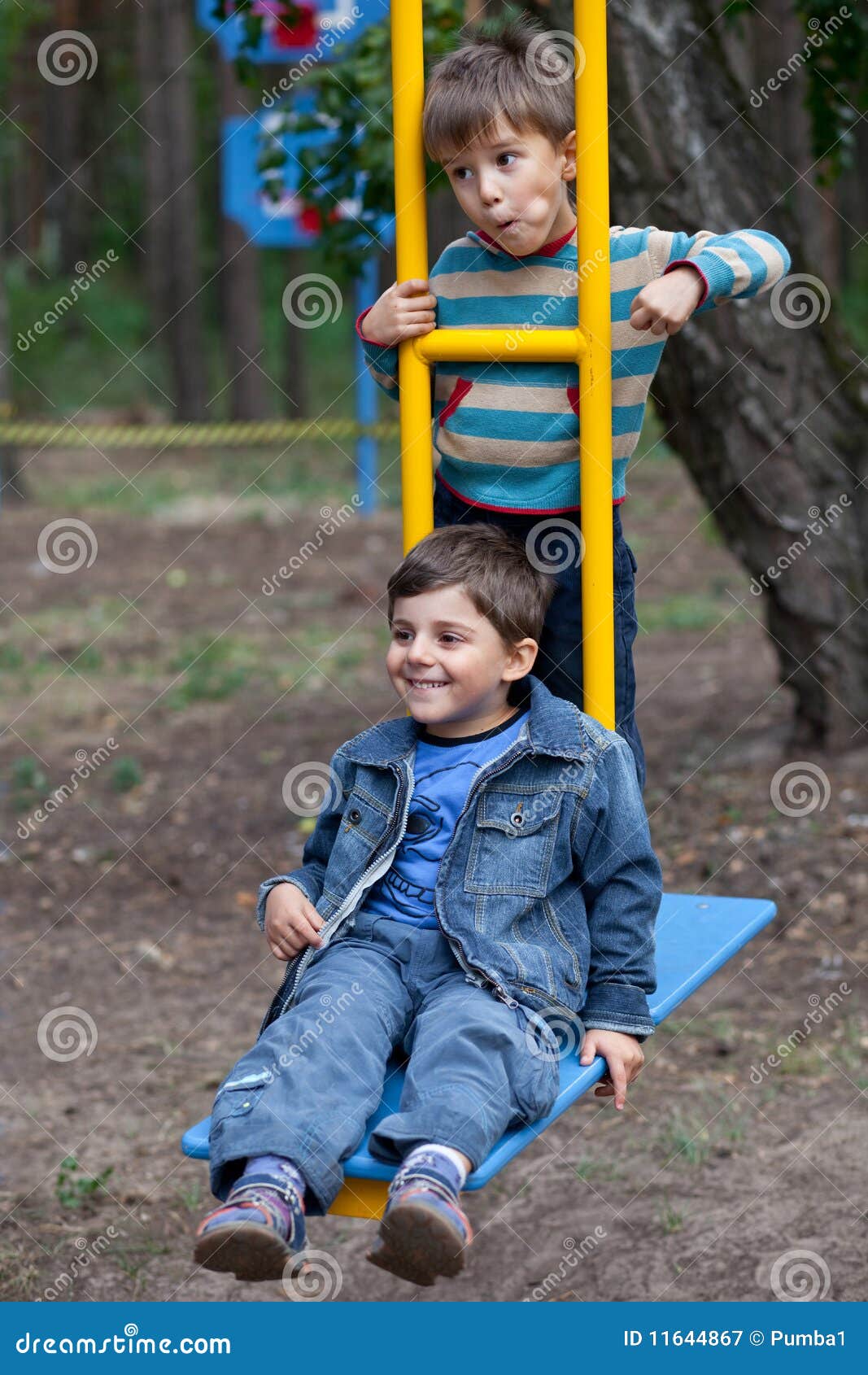 Two Boys Swing Together And Hold Chains Of Swings Royalty-Free Stock ...