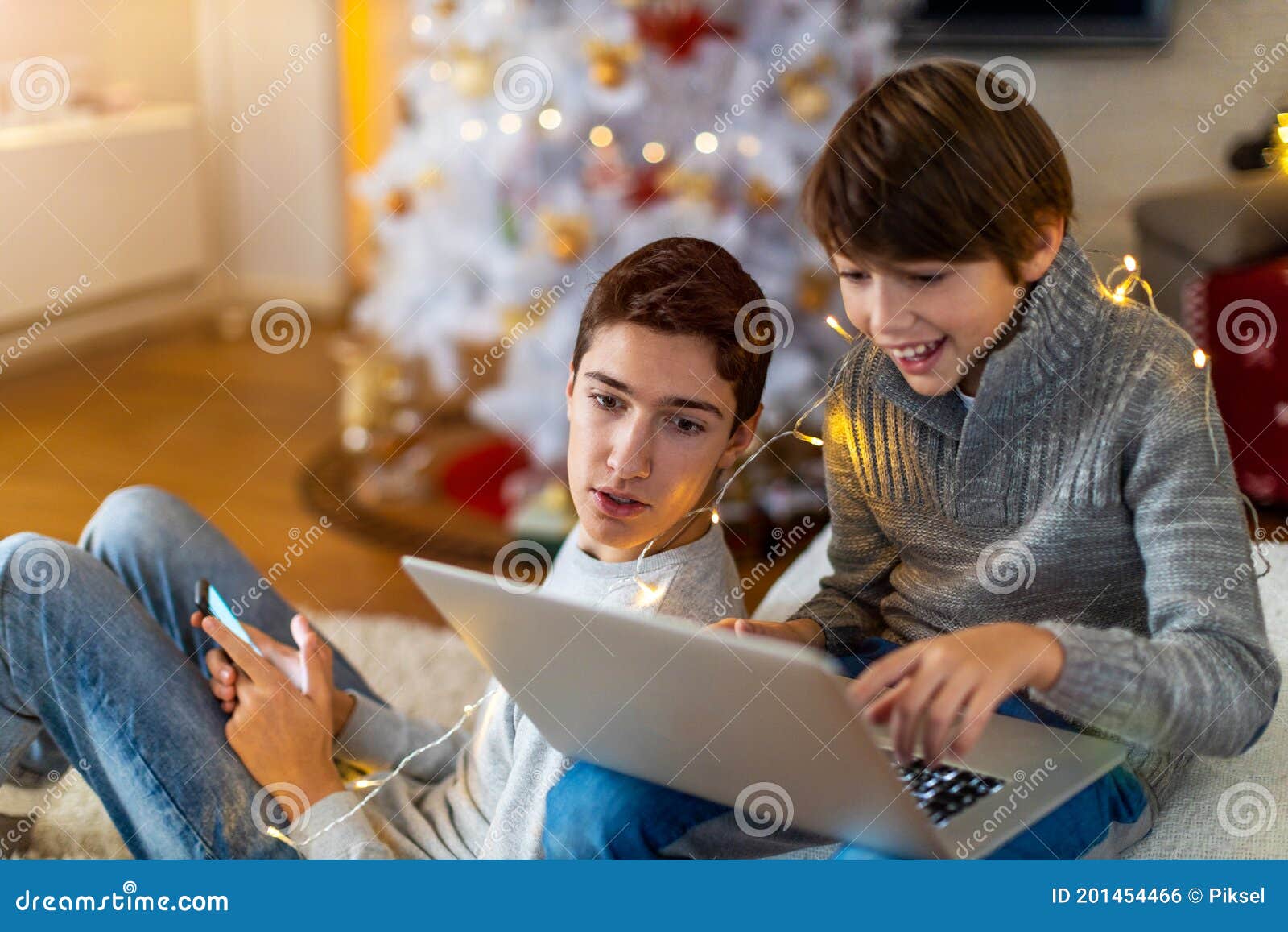 Two Boys Using Laptop by Christmas Tree Stock Photo - Image of ...