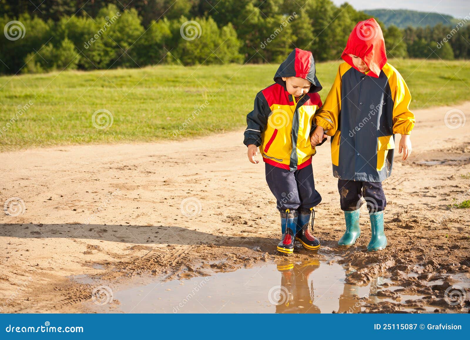 Two Boys Walking Through A Mud Puddle Royalty-Free Stock Photography ...
