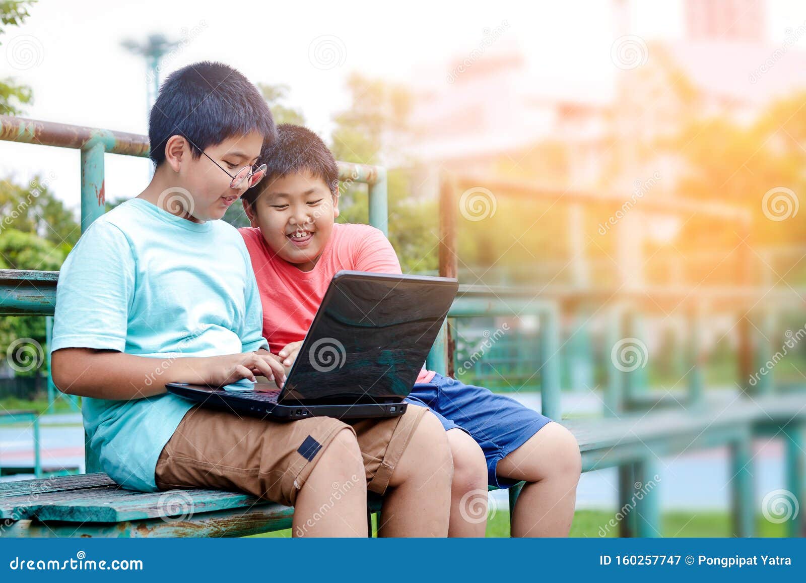 Two Boys Watching Computers Smile and Laugh Stock Image - Image of ...