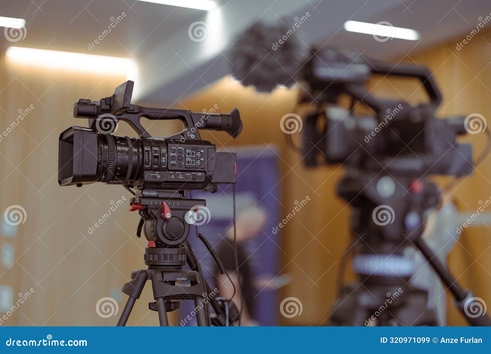 Two Broadcast Cameras Ready on a Tripod for a Conference or Live Event ...