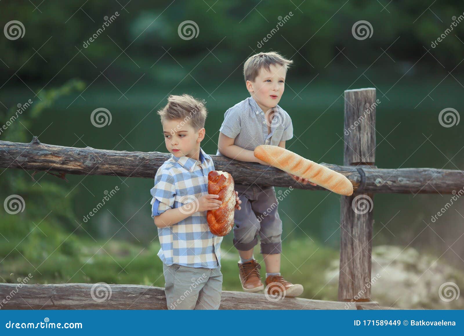 Two Brothers Eat Black Round Bread on a Wheat Field. Stock Image ...