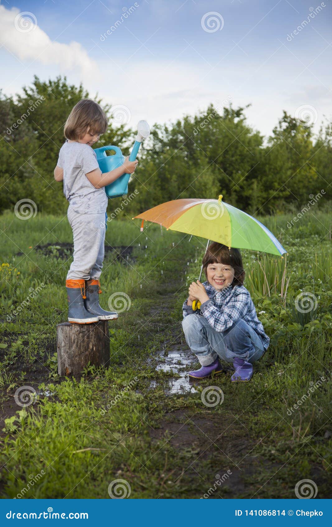Two Brothers Play in Rain Outdoors Stock Photo - Image of female, play ...