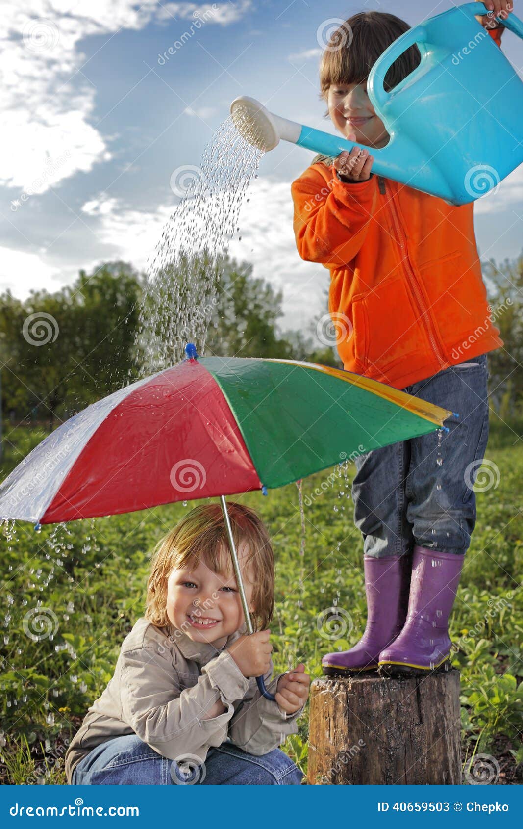 Two brothers play in rain stock image. Image of green - 40659503