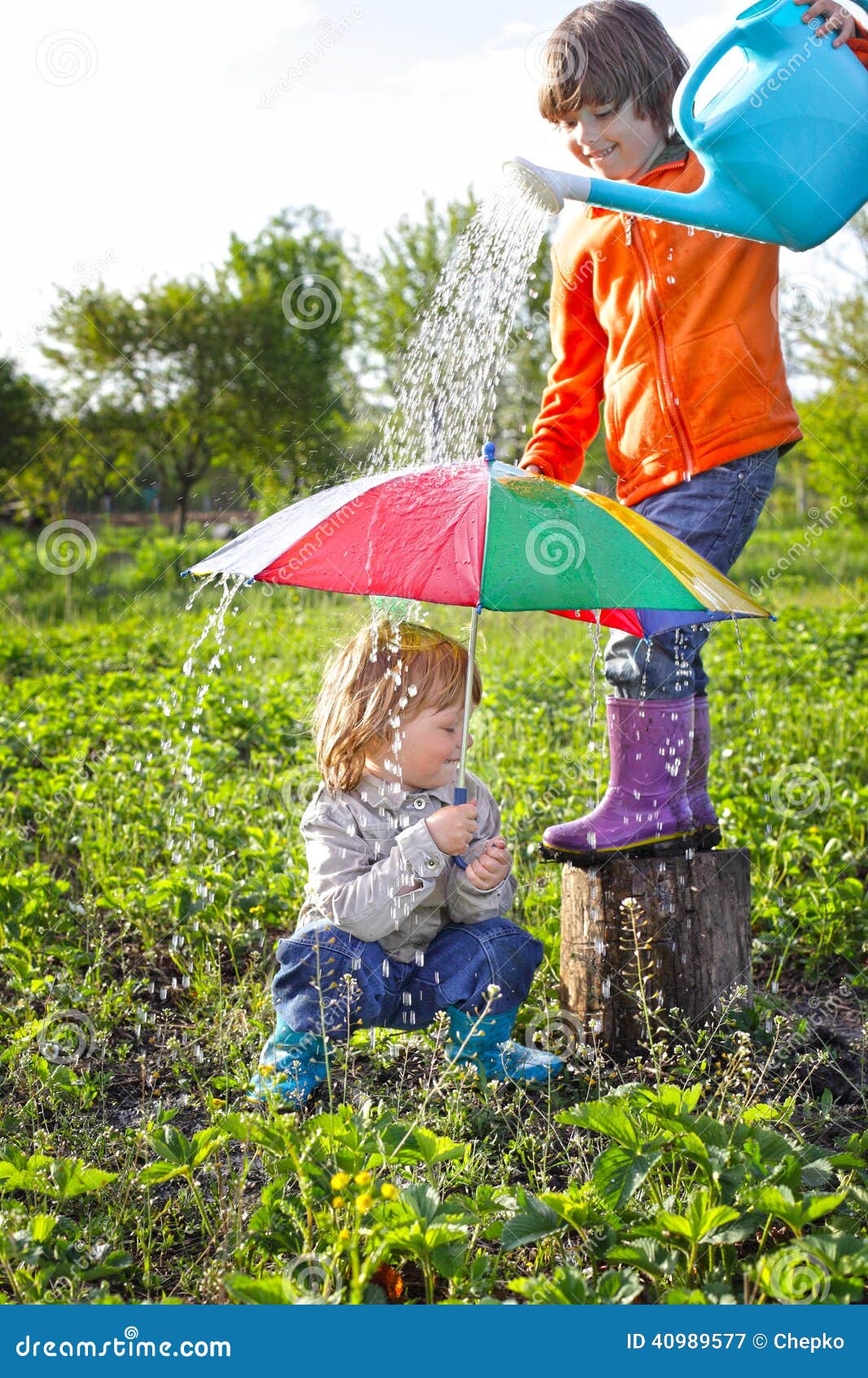 Two brothers play in rain stock image. Image of activity - 40989577