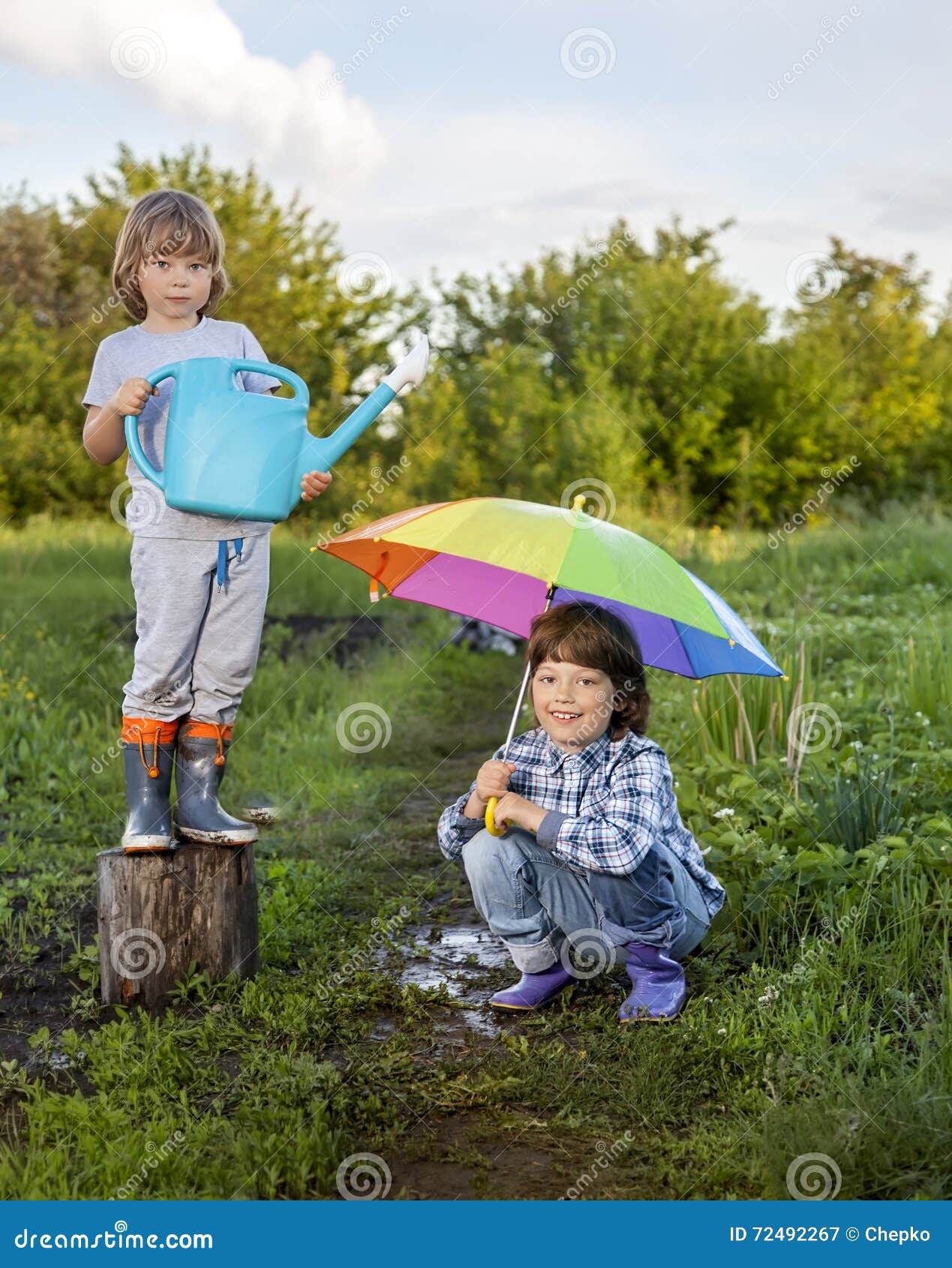 Two brothers play in rain stock image. Image of grass - 72492267