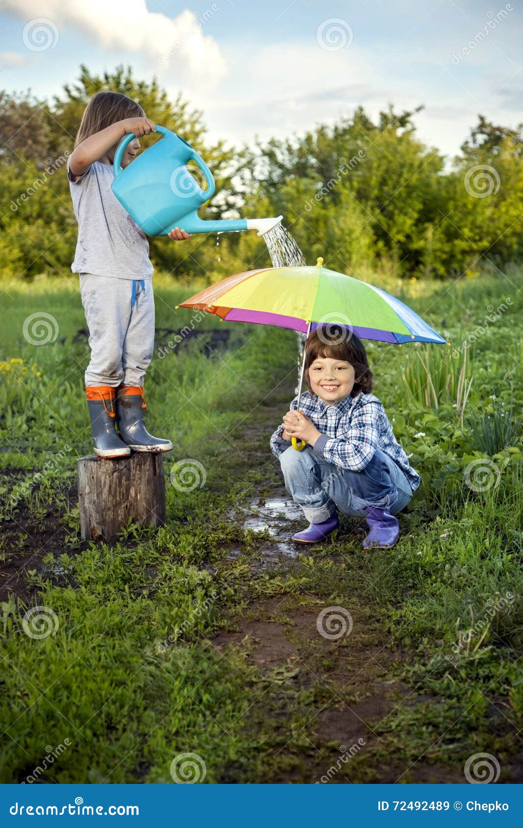 Two brothers play in rain stock image. Image of play - 72492489