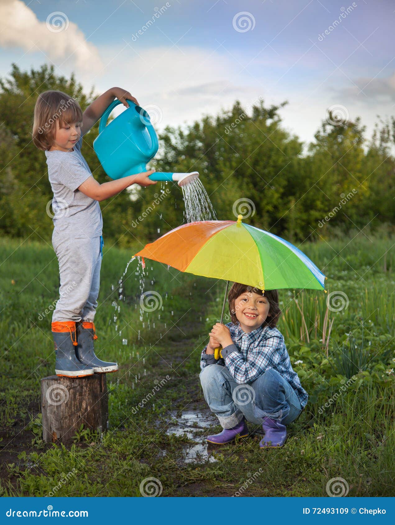 Two brothers play in rain stock image. Image of multi - 72493109