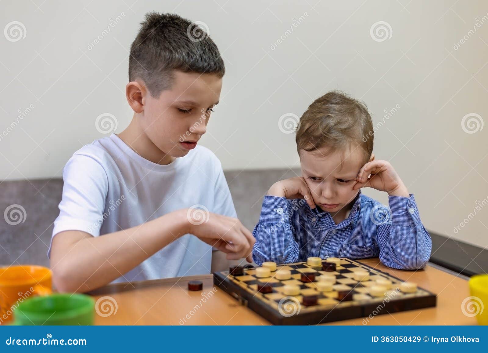 Two Brothers Playing Checkers, Older Sibling in White Shirt Makes a ...