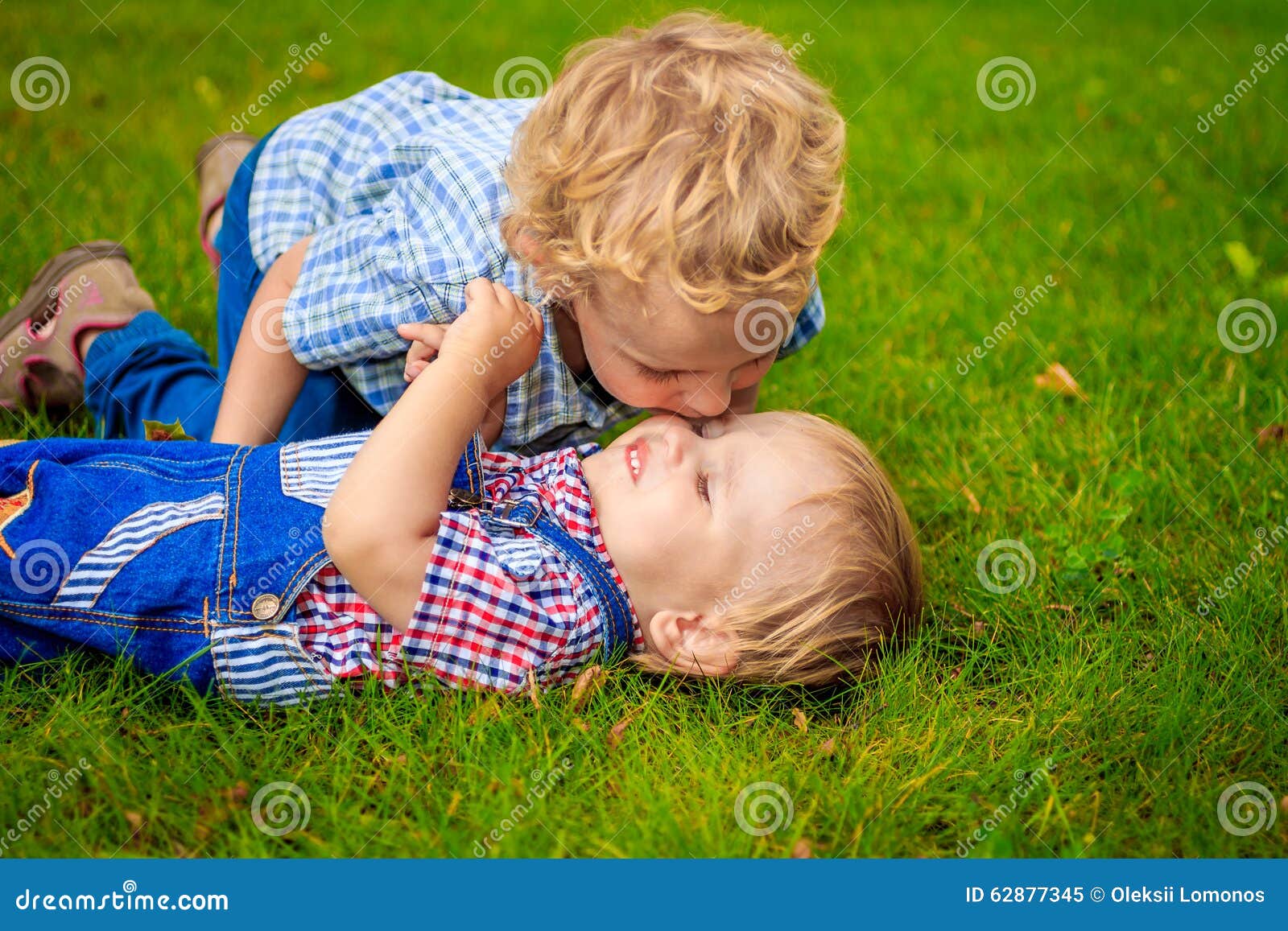 Two Brothers Playing on the Lawn in the Park Stock Image - Image of ...