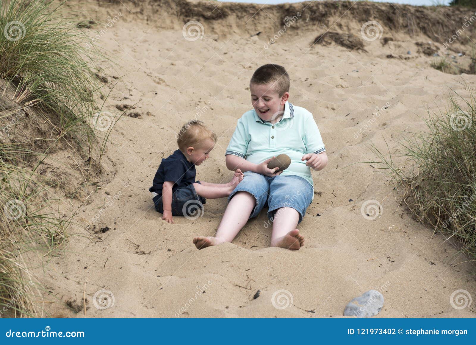 Two Brothers Playing in the Sand Stock Photo - Image of family ...