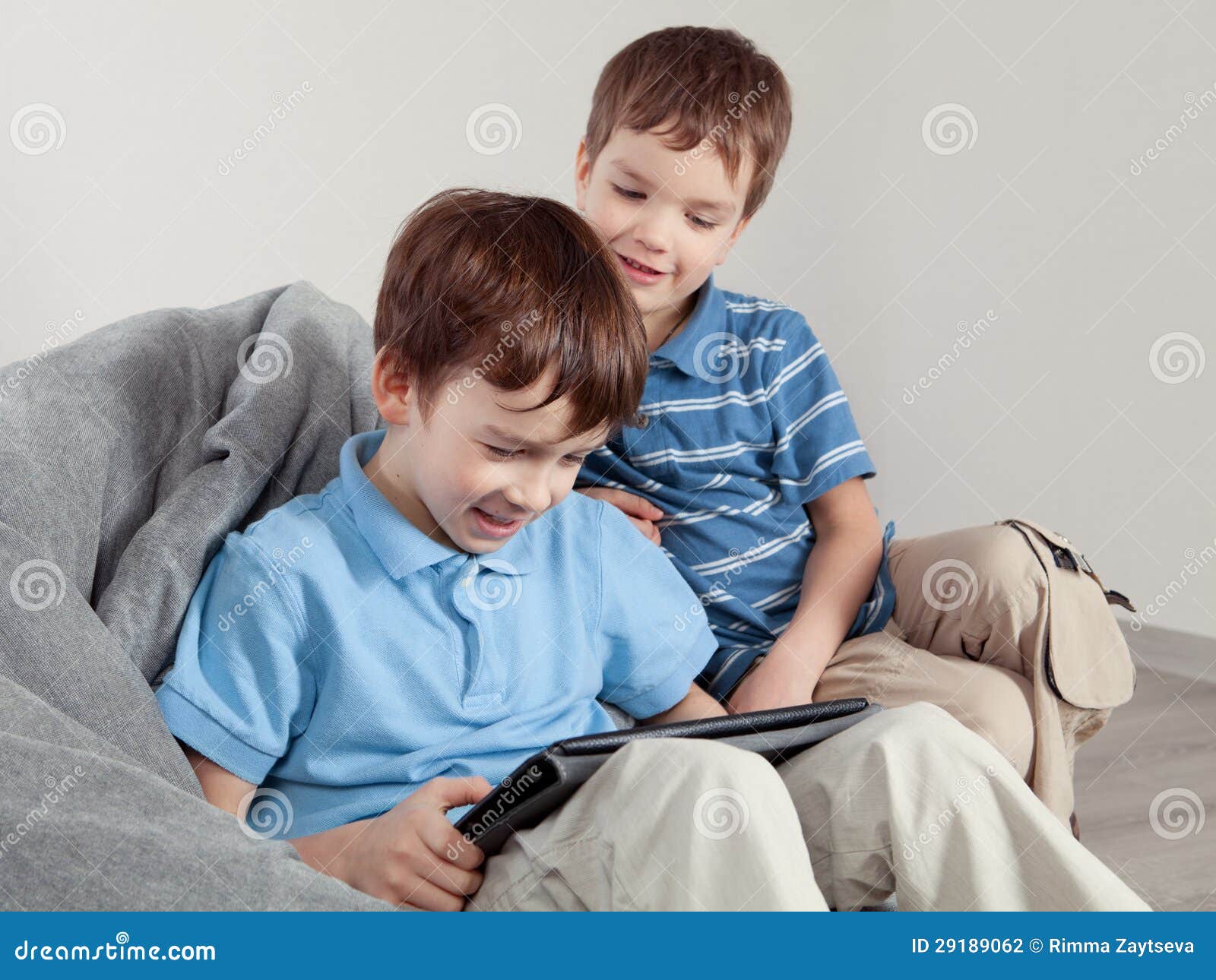 Two Brothers Playing on Tablet Stock Photo - Image of touchscreen ...