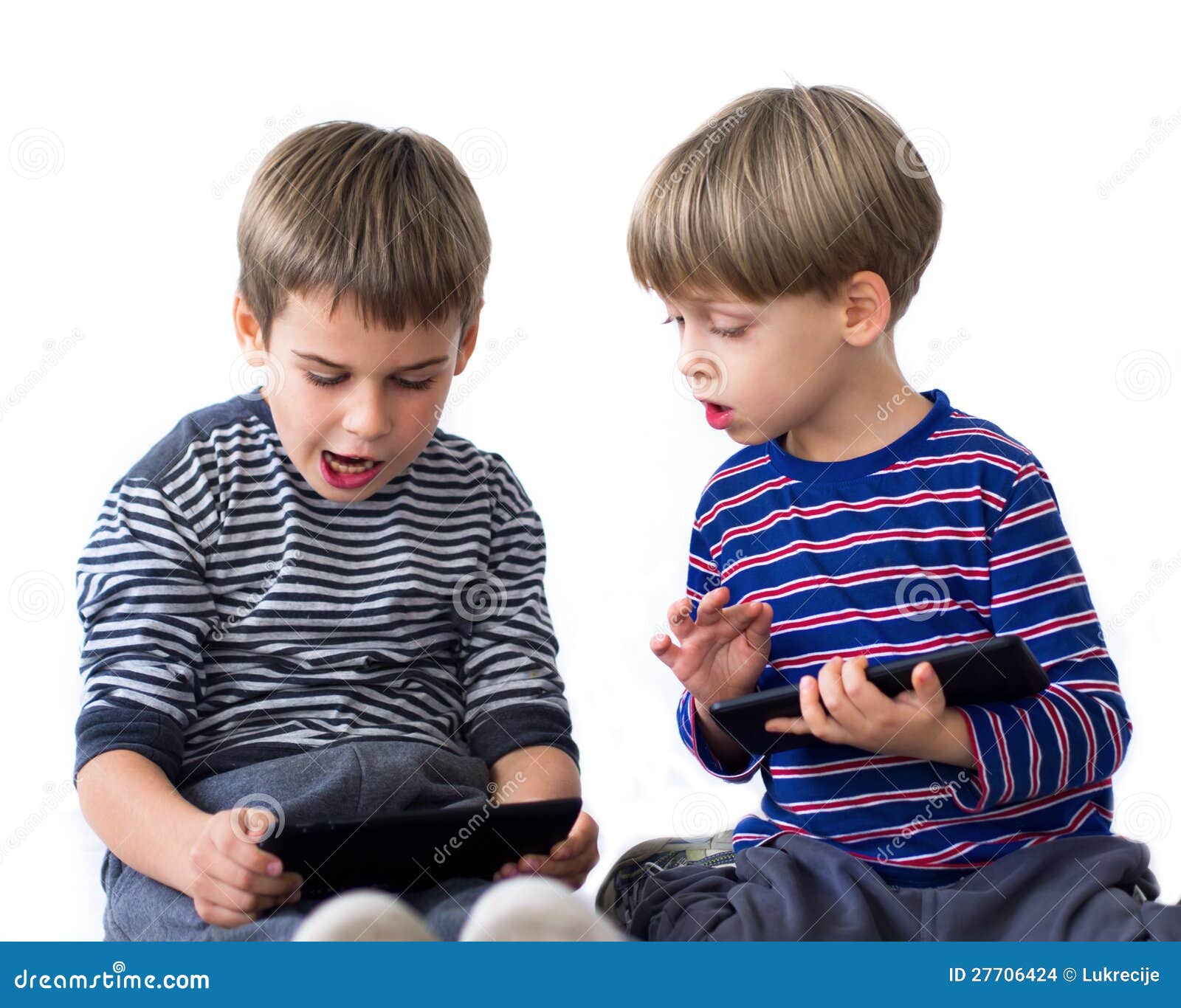 Two Brothers Playing Video Games on Tablets Stock Photo - Image of ...