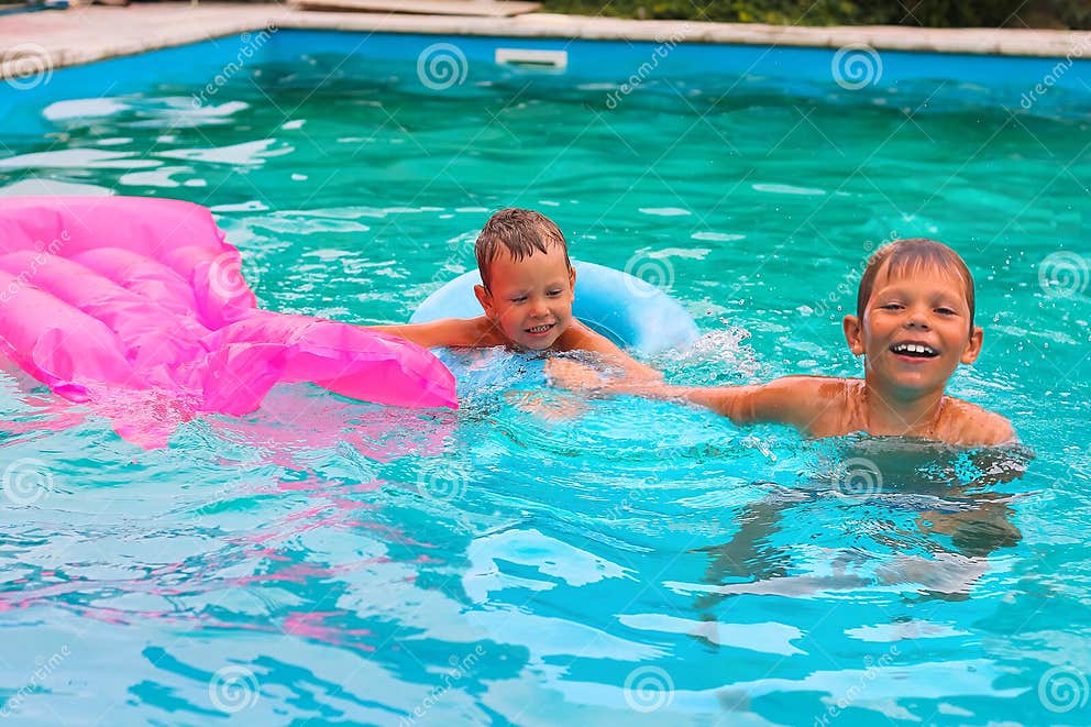 Two brothers in the pool stock image. Image of playing - 32116991
