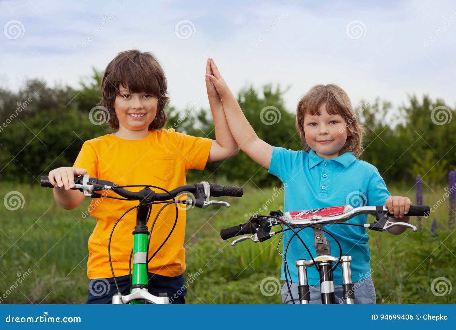 Two brothers ride bikes stock photo. Image of lifestyles - 94699406