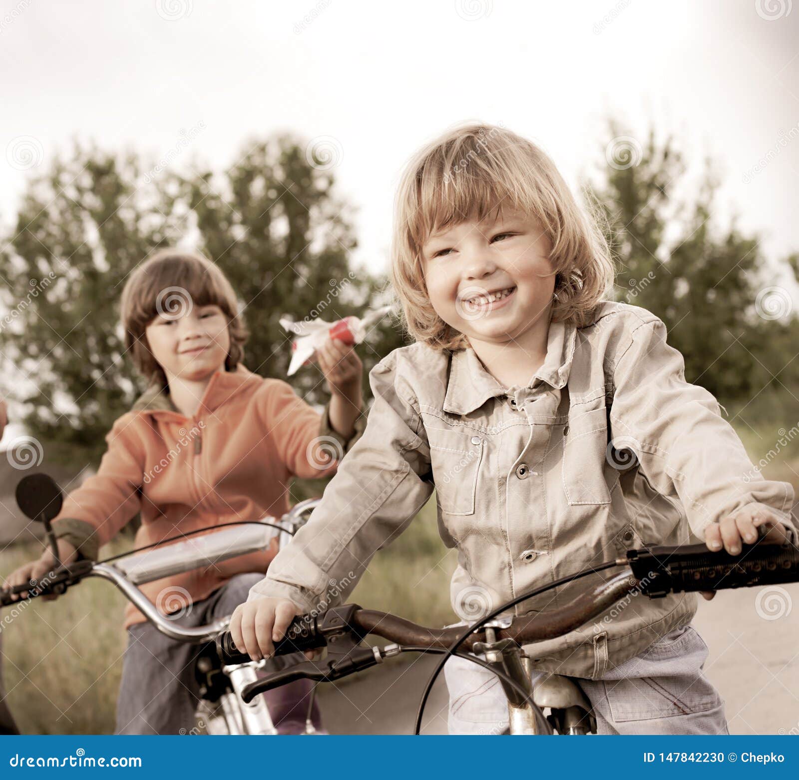 Two brothers ride bikes stock photo. Image of healthy - 147842230