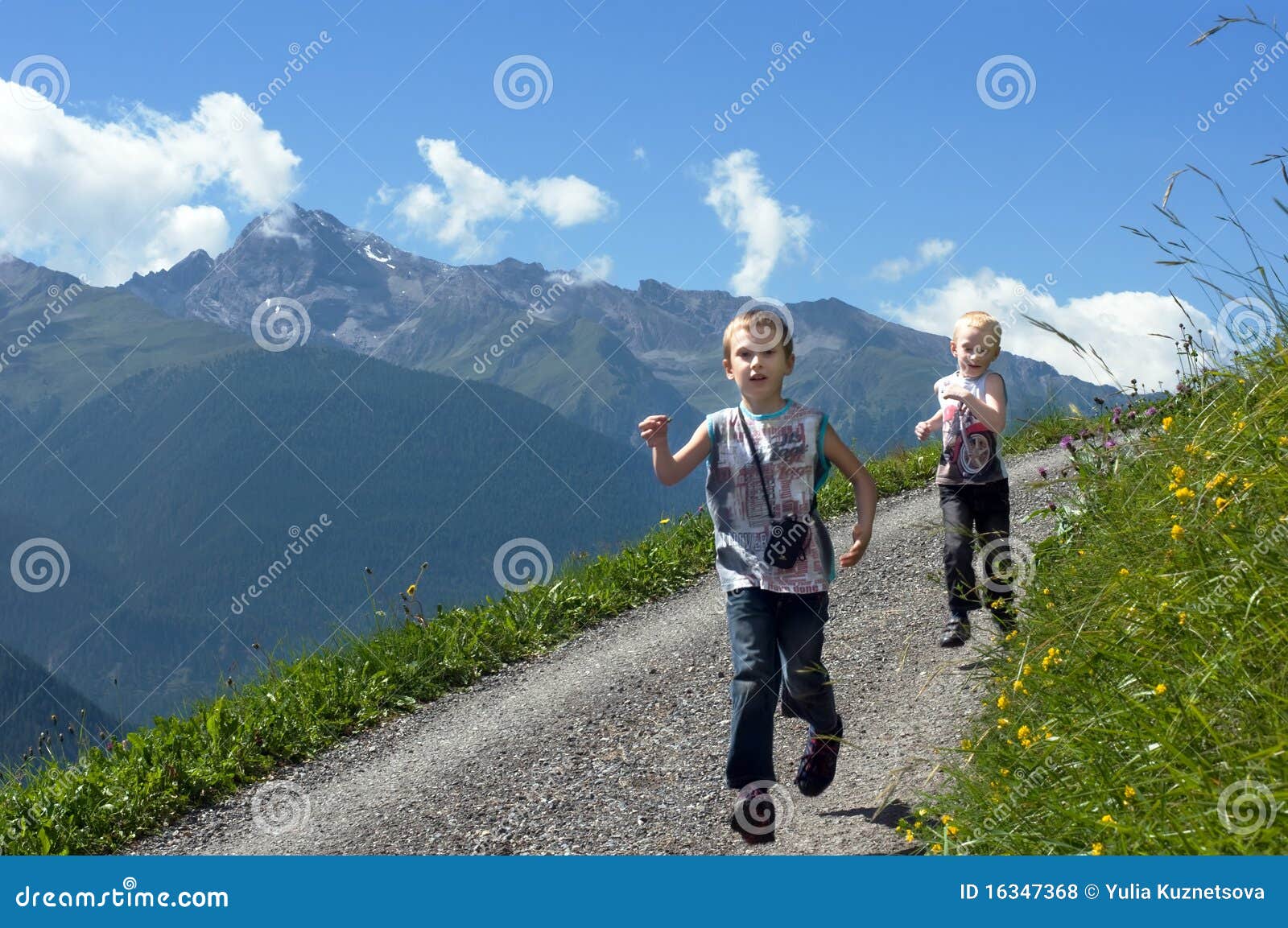 Two Brothers Are Running Along A Dirt Road In A Field And Holding Hands ...