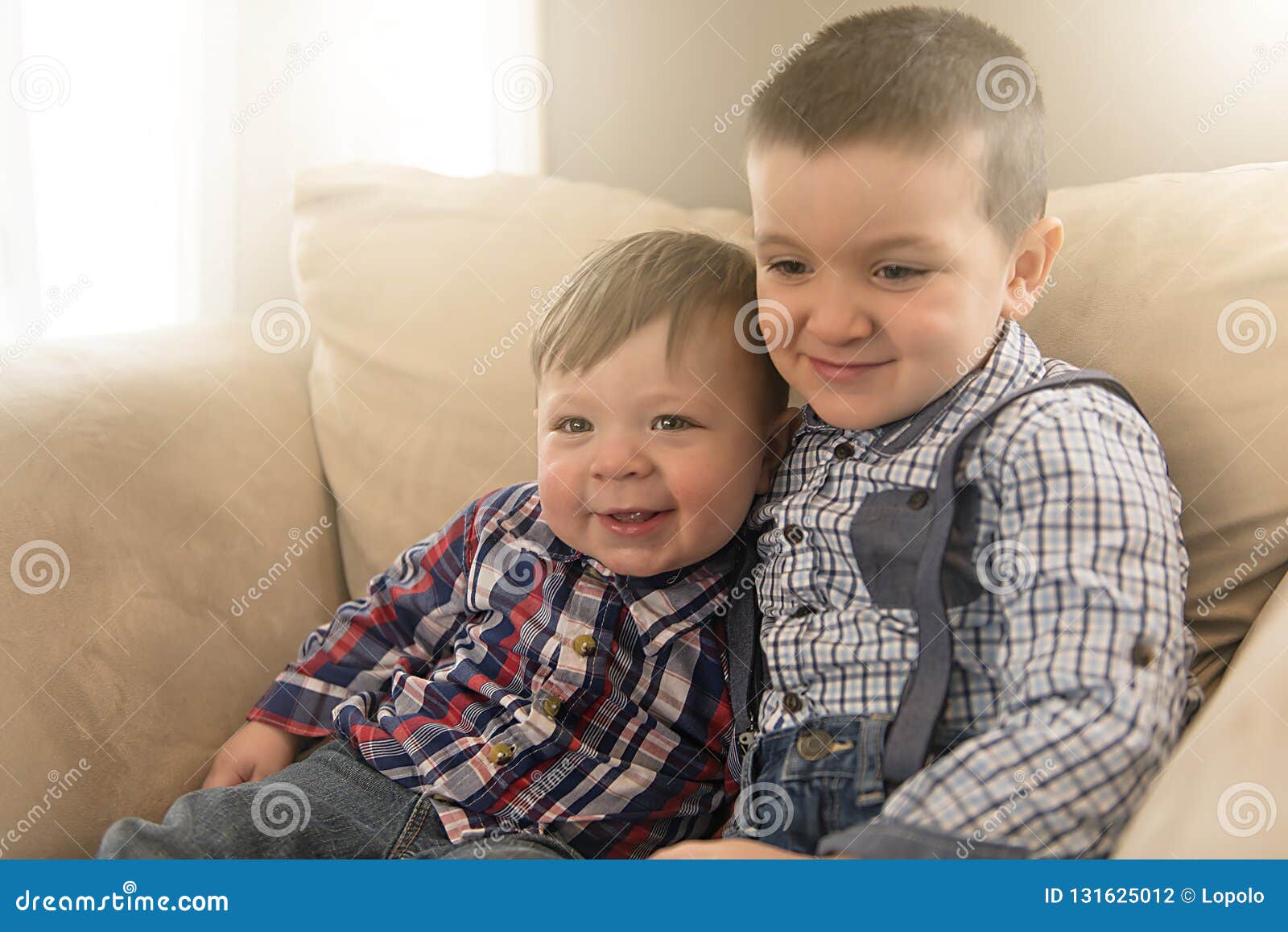 Two Brothers Sitting Embracing on the Couch Stock Photo - Image of ...