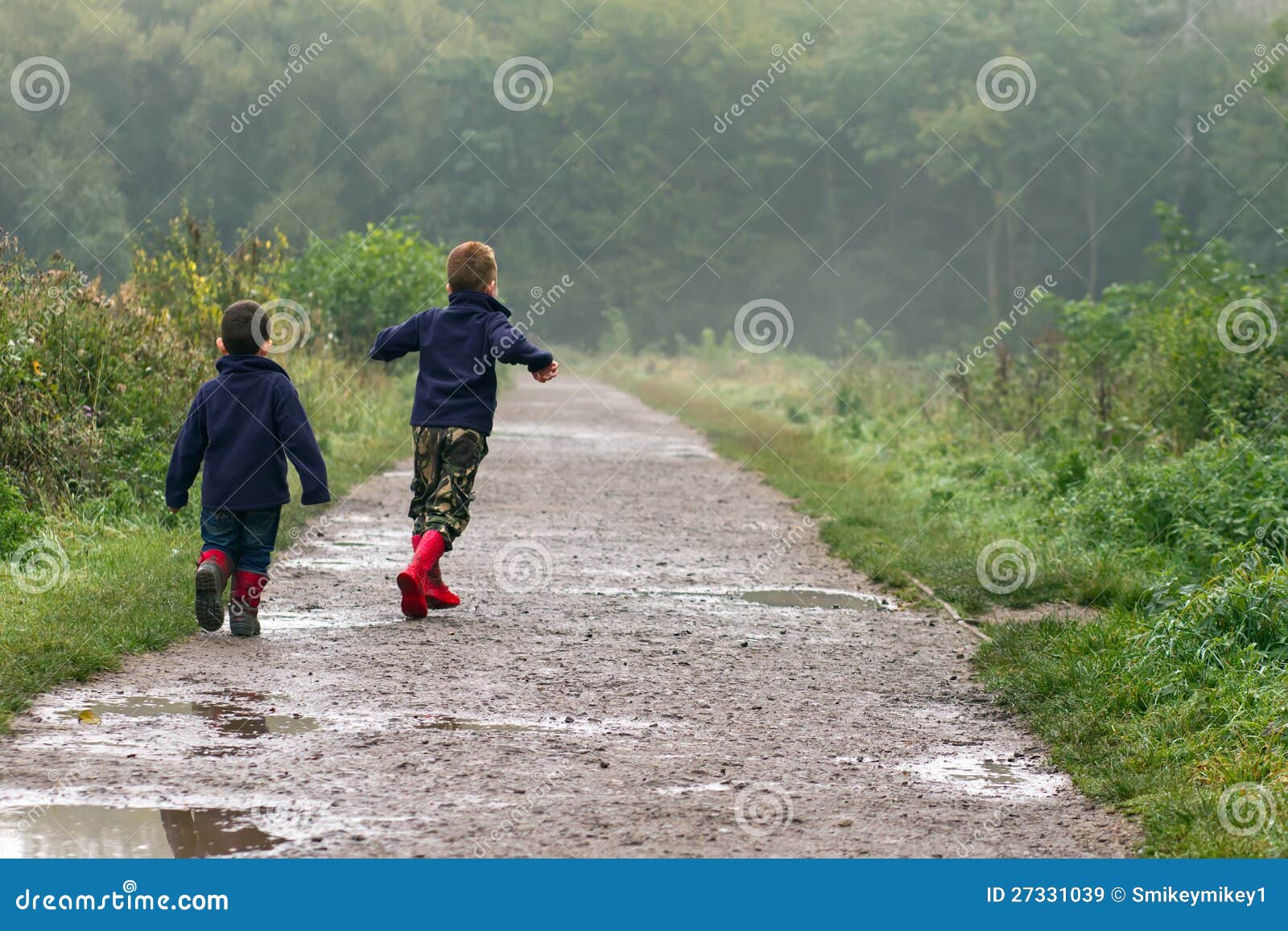 Two Brothers Splashing in Puddles Stock Image - Image of hair, muddy ...