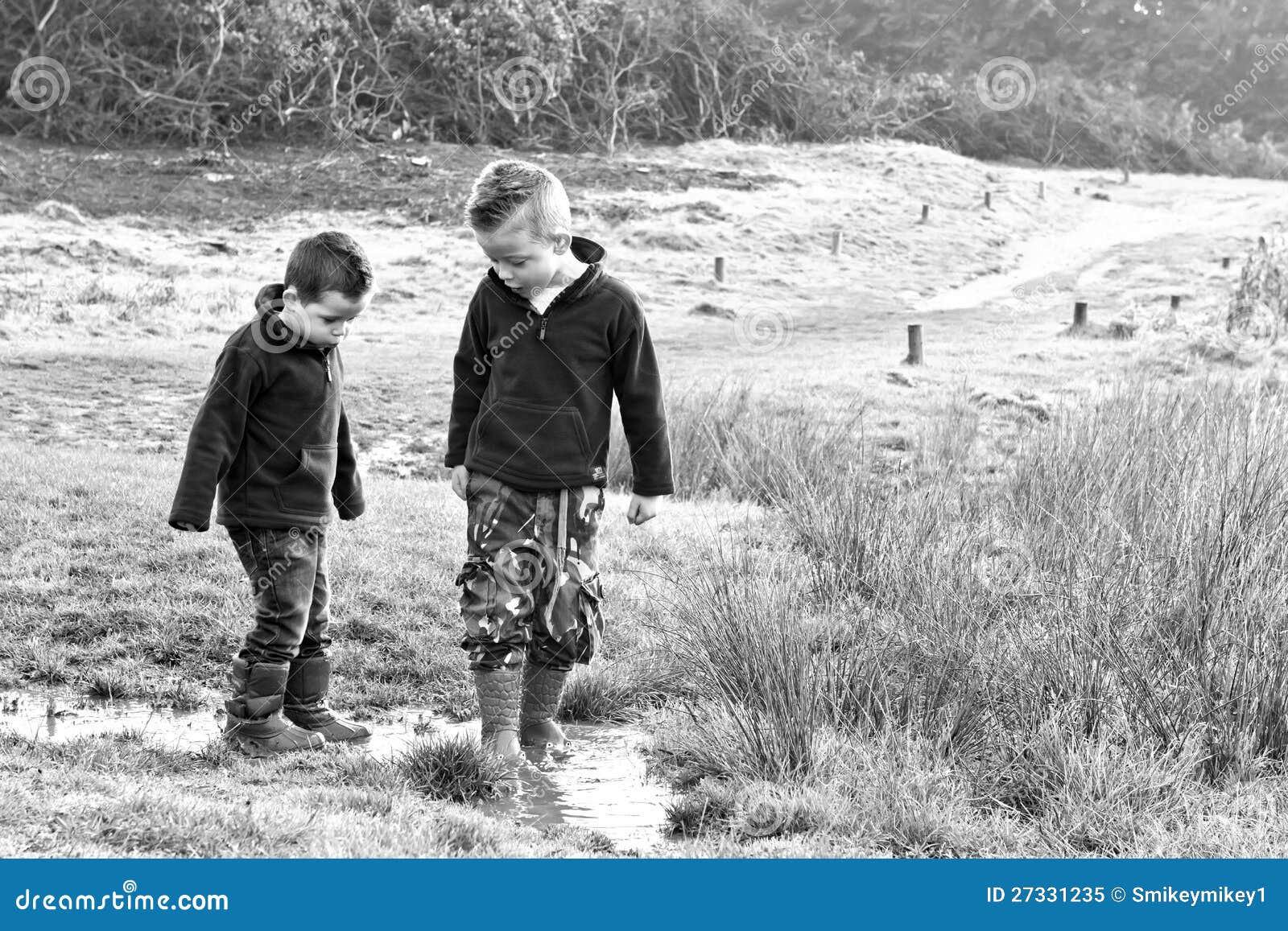 Two Brothers Splashing in Puddles Stock Image - Image of baby, rain ...