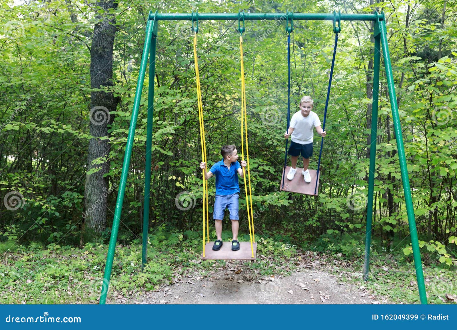 Two Brothers Swinging on Swing Stock Image - Image of carefree ...