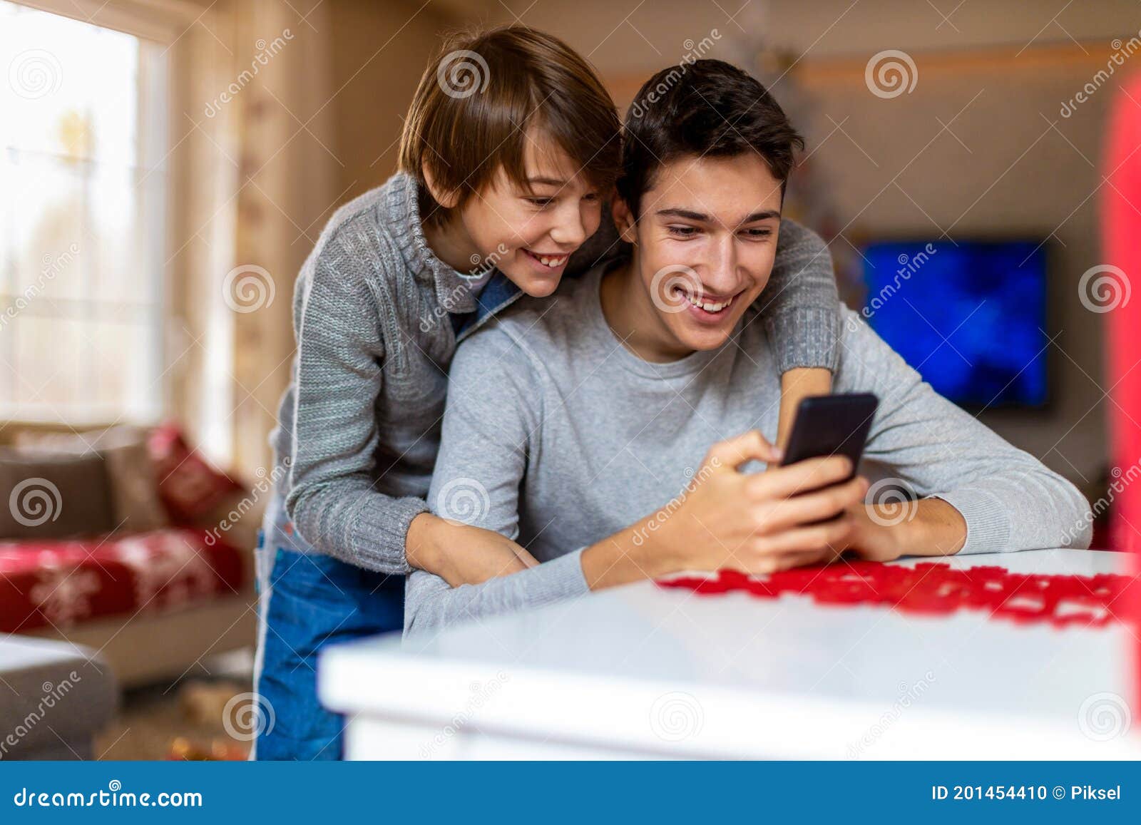 Two Brothers Using Mobile Phone Together Stock Photo - Image of ...