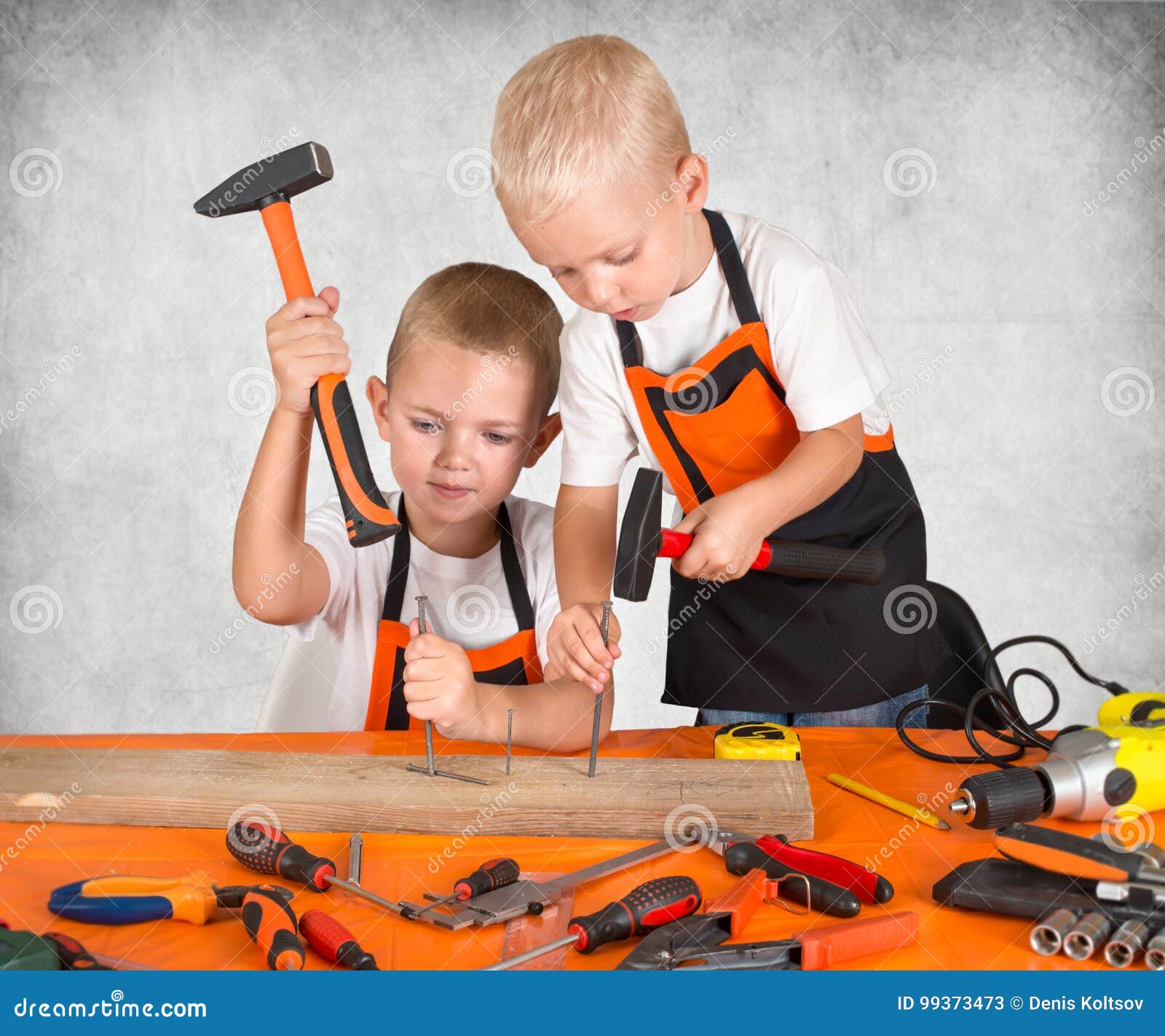 Two Brothers Working in the Carpentry Workshop.Hammer Nails into a ...