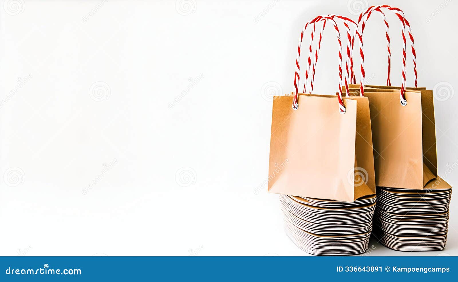Two Brown Paper Bags on a Stack of Magazines Against a White Background ...