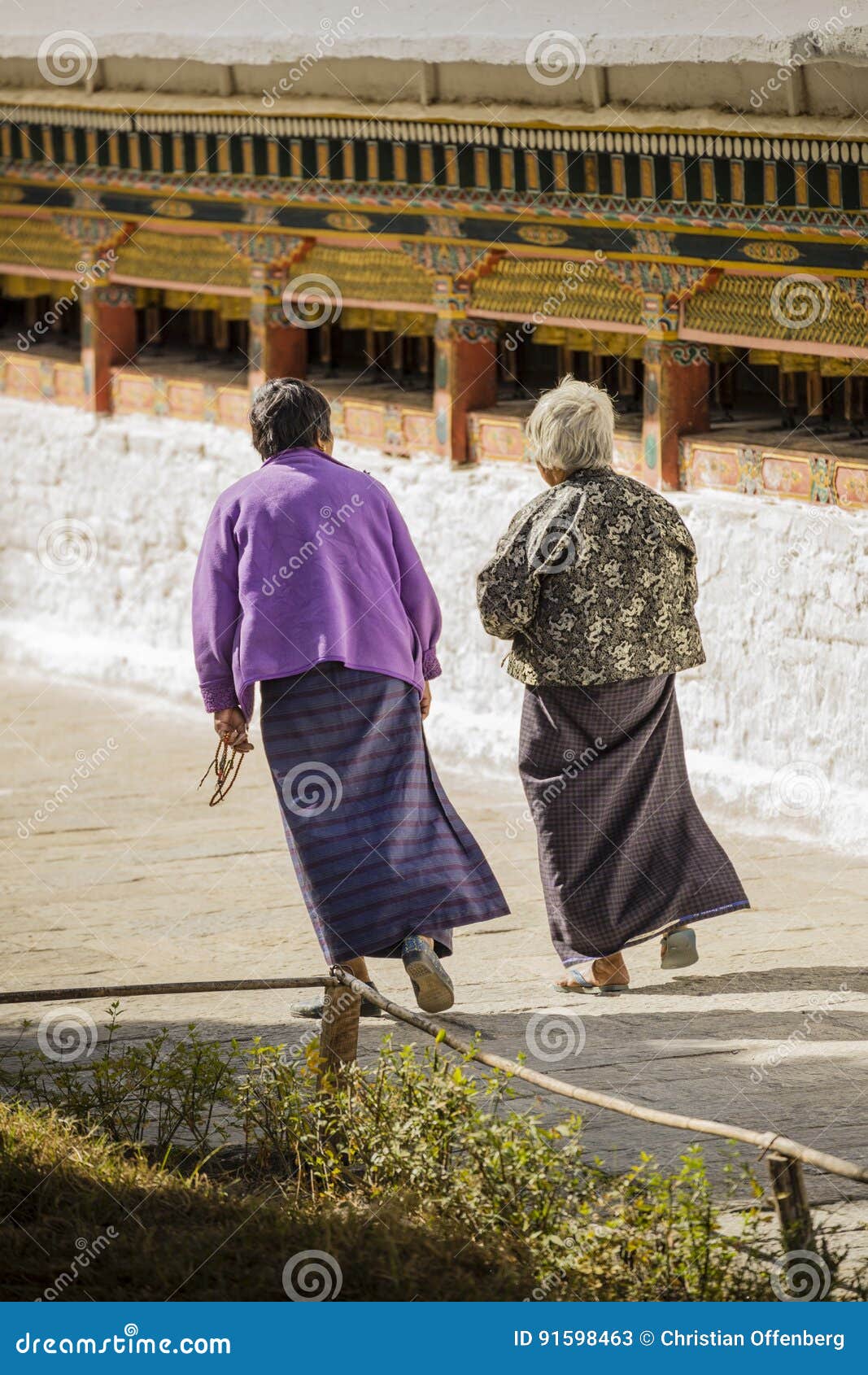 Two Buddhist Devotee Walking Alongside Prayer Wheels Editorial Stock ...