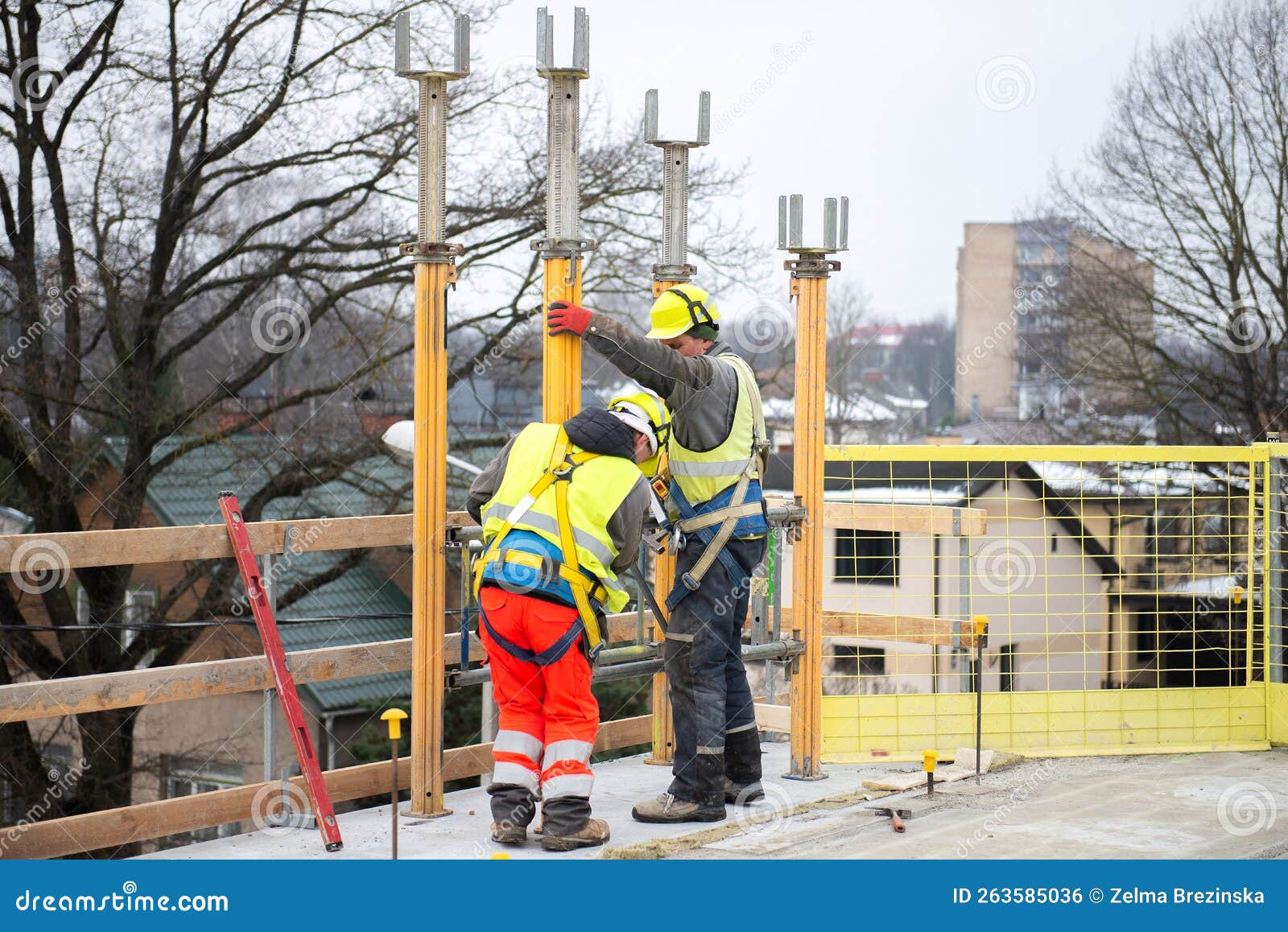 Two Builder Construction Workers in the Work Process on Building Site ...